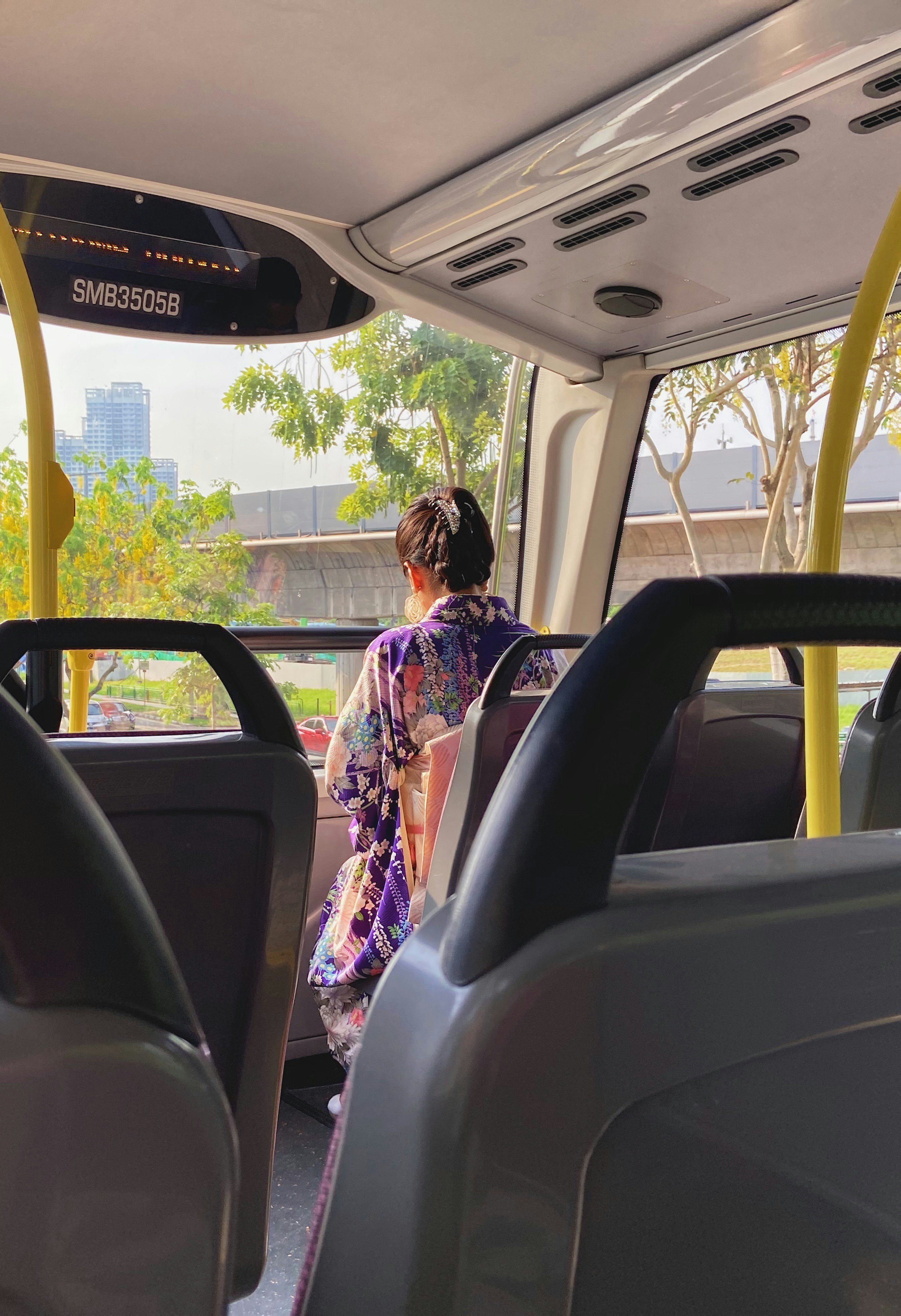 Kimono in Transit: A Sunlit Moment on a City Bus