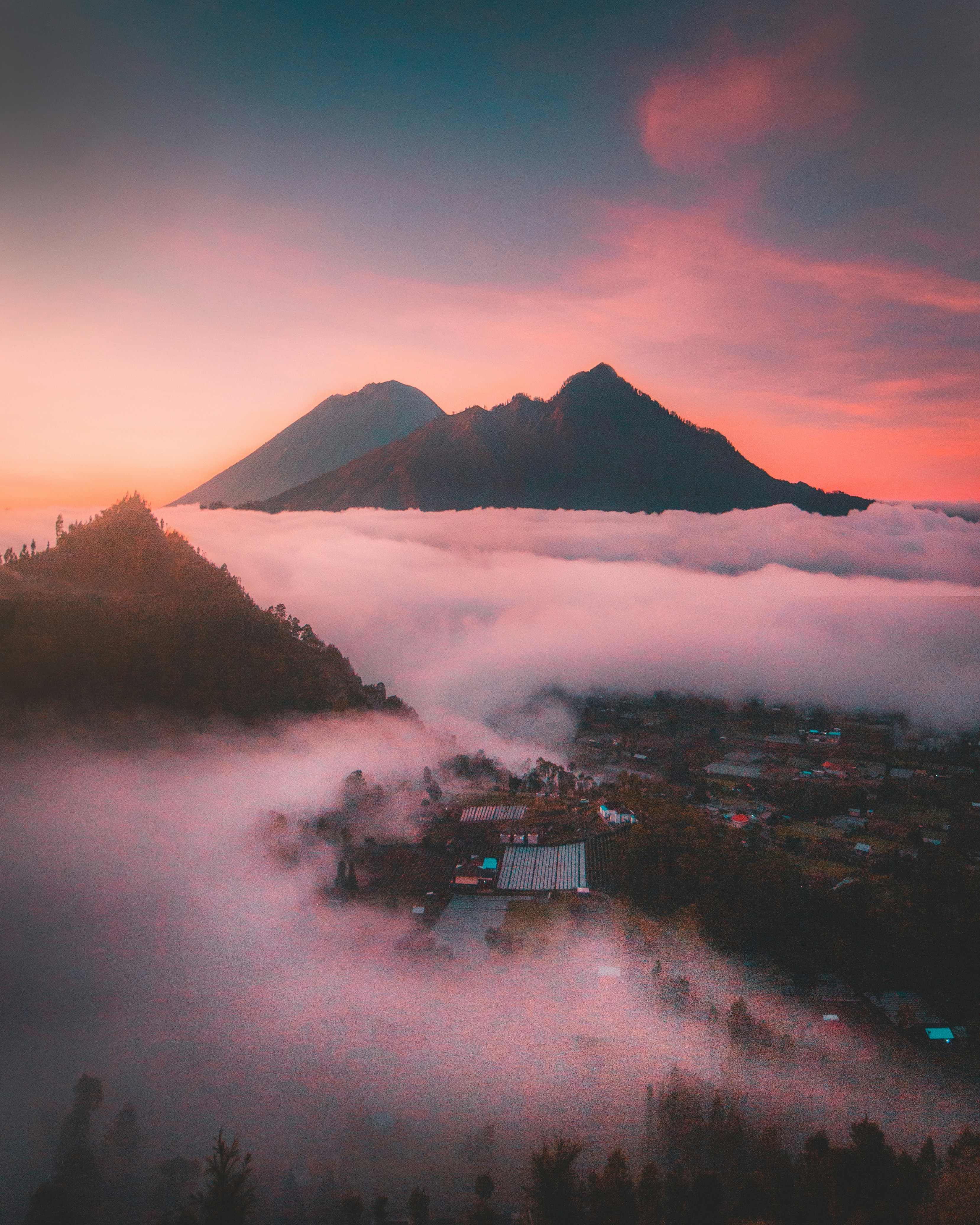 Dawn over Velvet Clouds: Twin Peaks Stand Guard Above a Quiet Valley