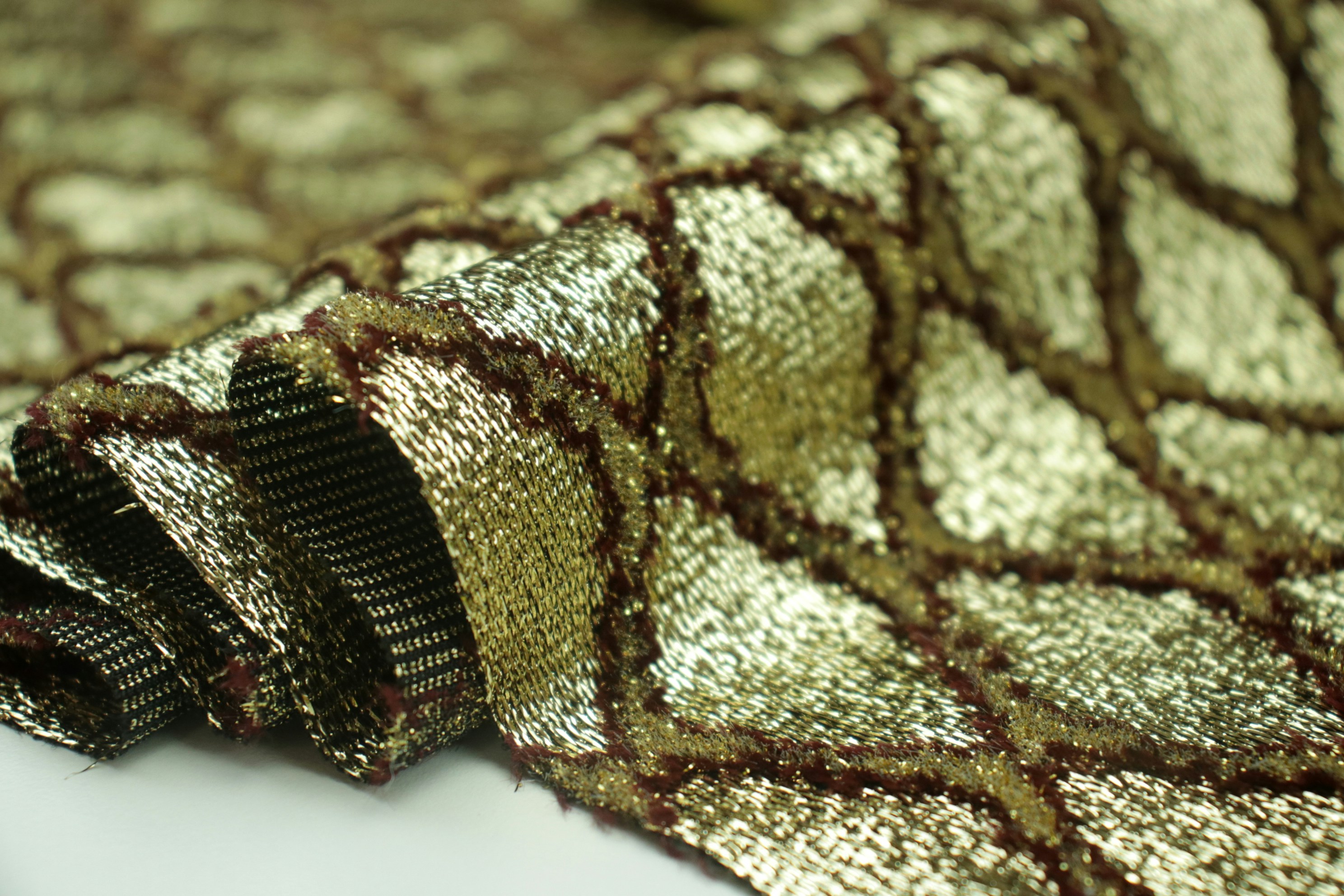 Gilded Mesh: Macro Portrait of Light on Metallic Fabric