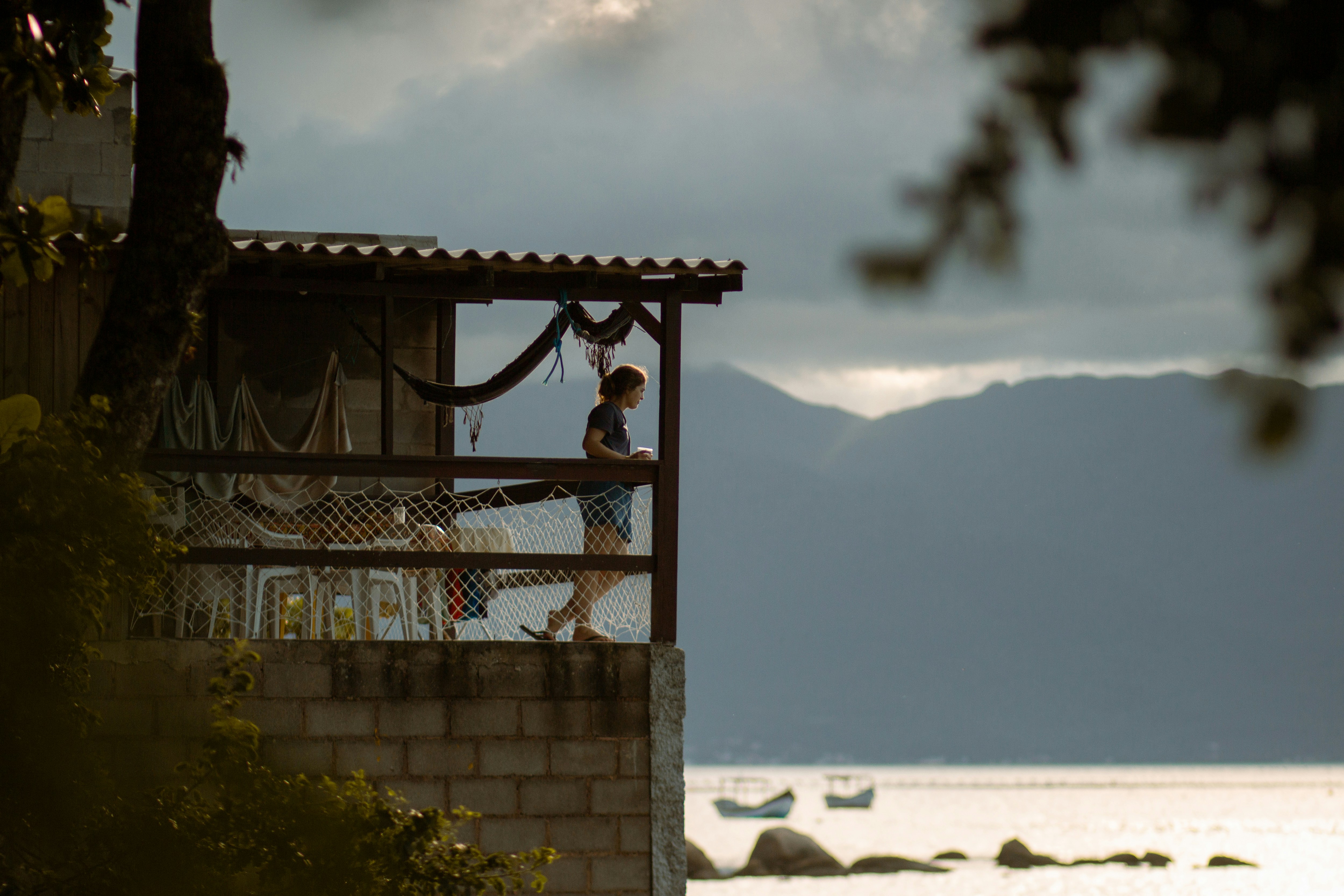 Balcony in the Mist: a solitary figure framed by lake and mountains