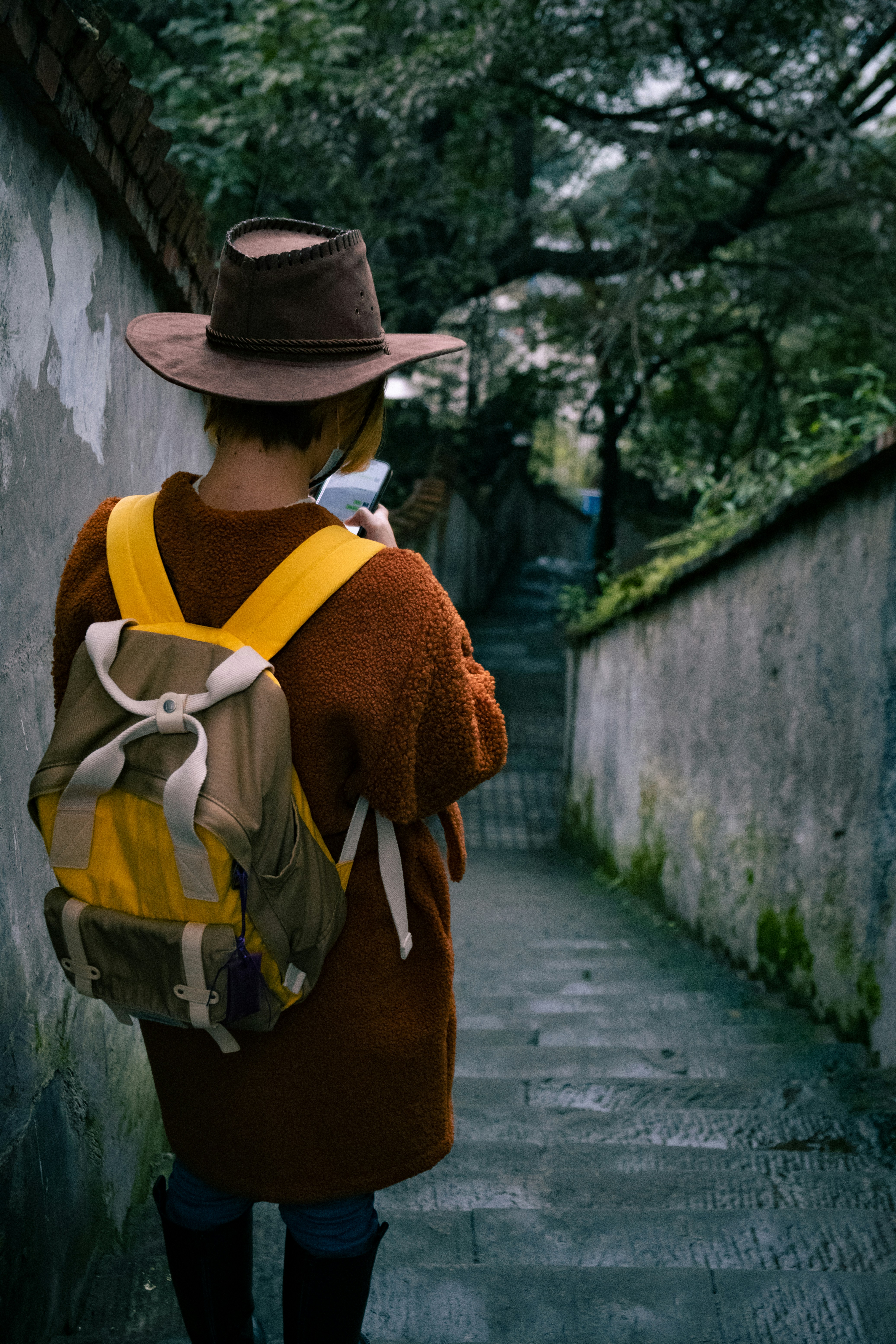 Yellow-Strapped Traveler Ascends a Quiet Mossy Staircase