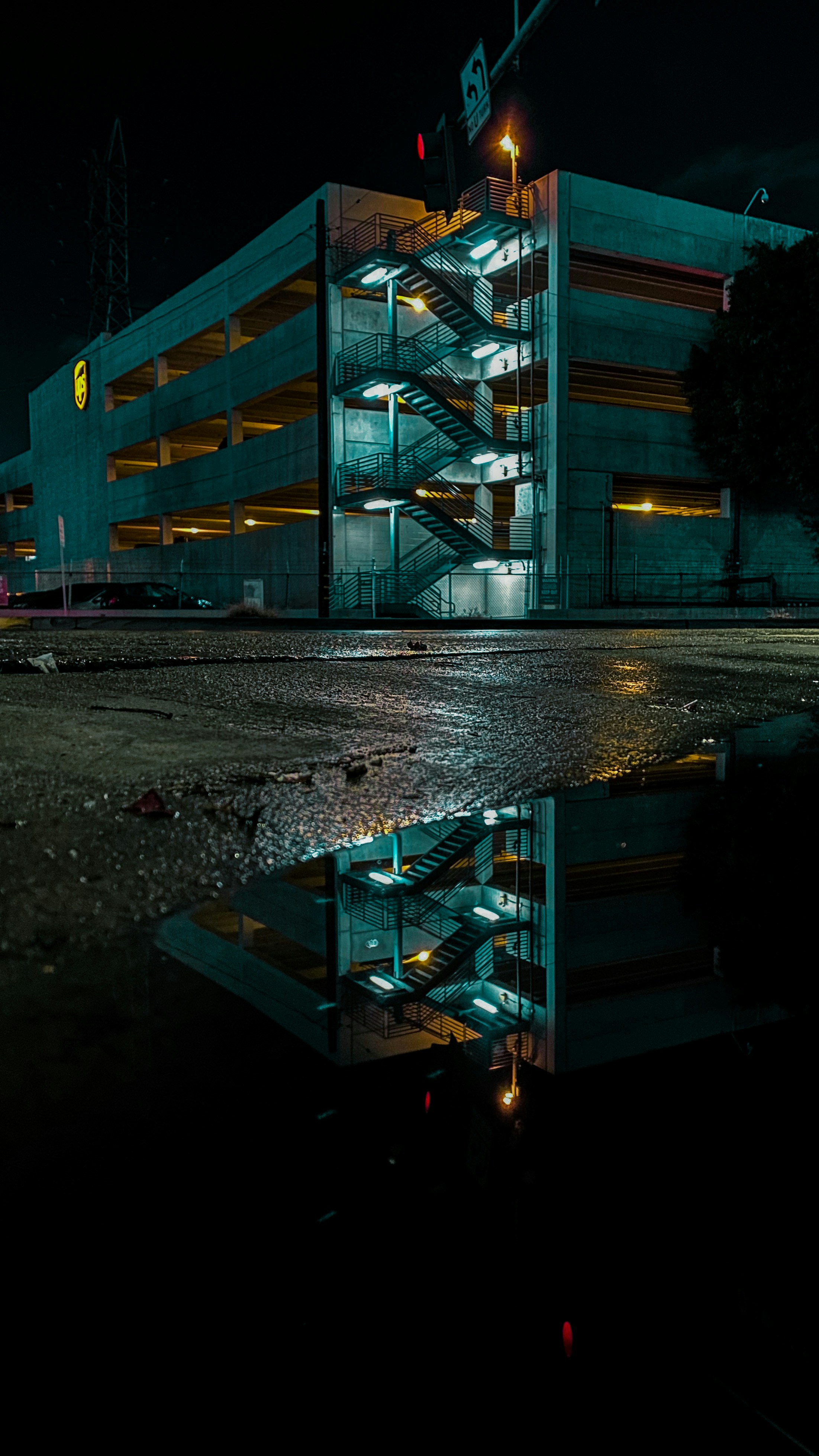 Neon Staircase Echoes: Night Parking Garage Reflections