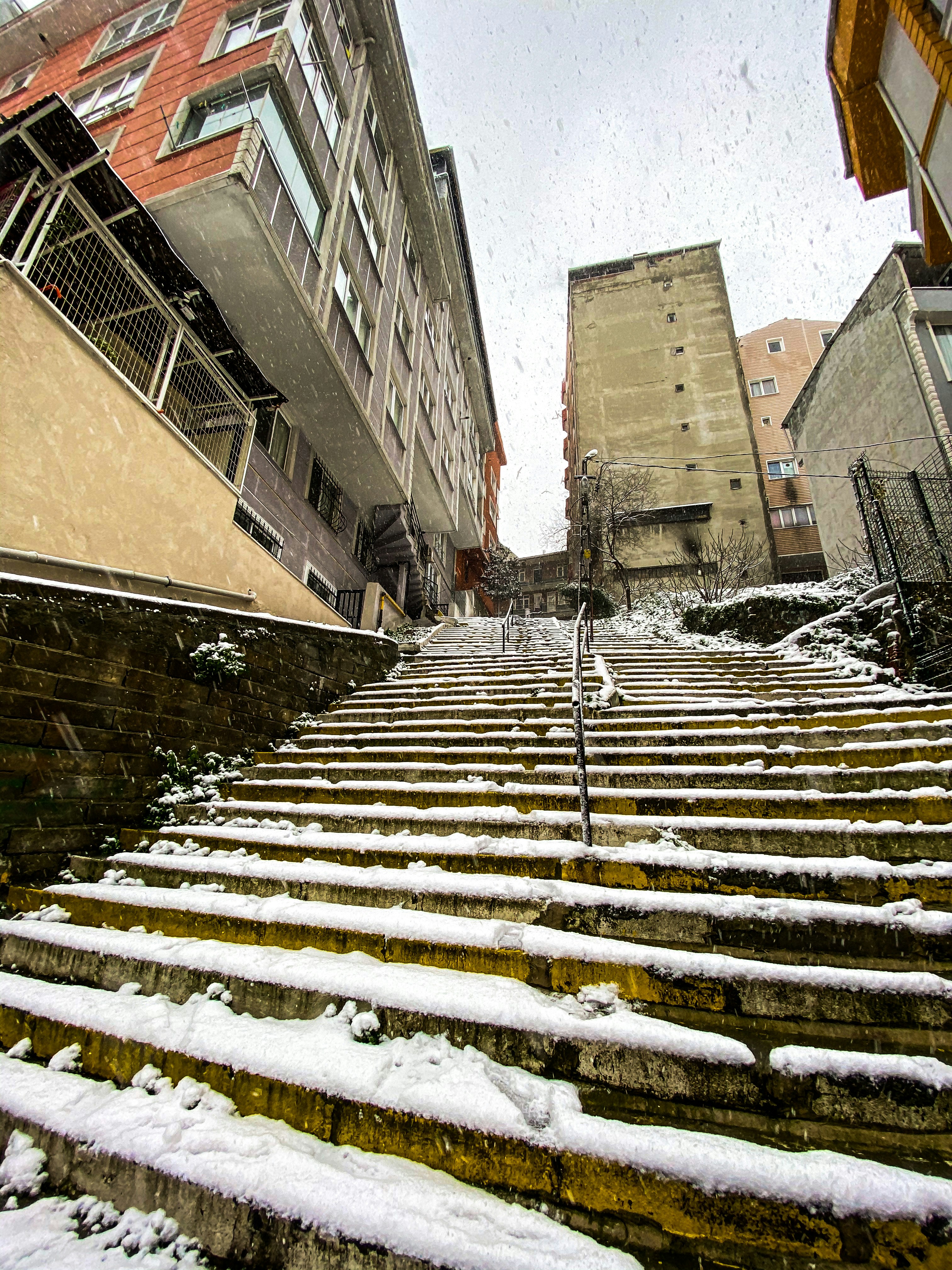 Urban Staircase in Snow: Converging Lines Toward a Narrow Sky