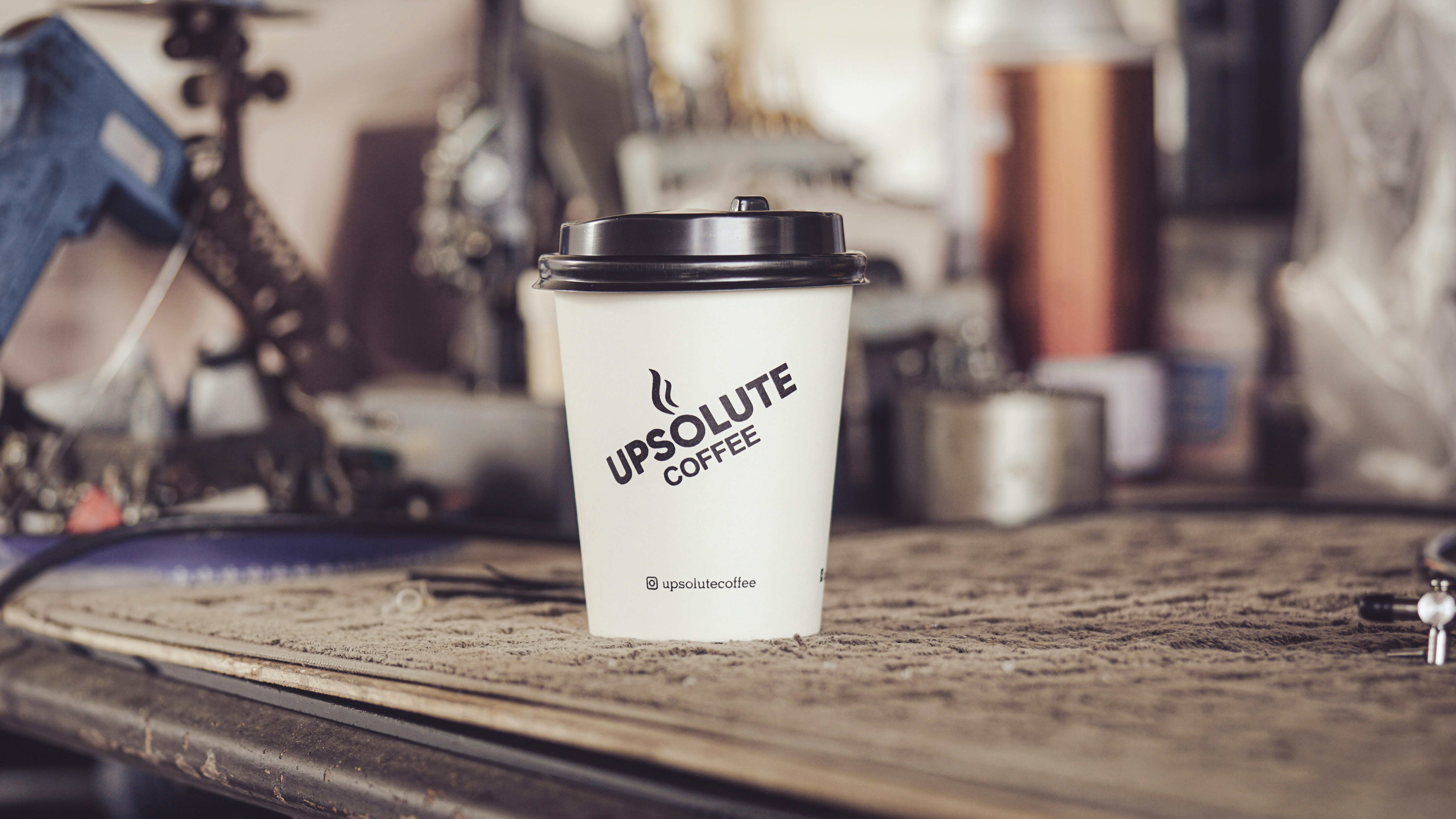 Stillness in the Workshop: A Solo Coffee Cup Under Warm, Diffused Light