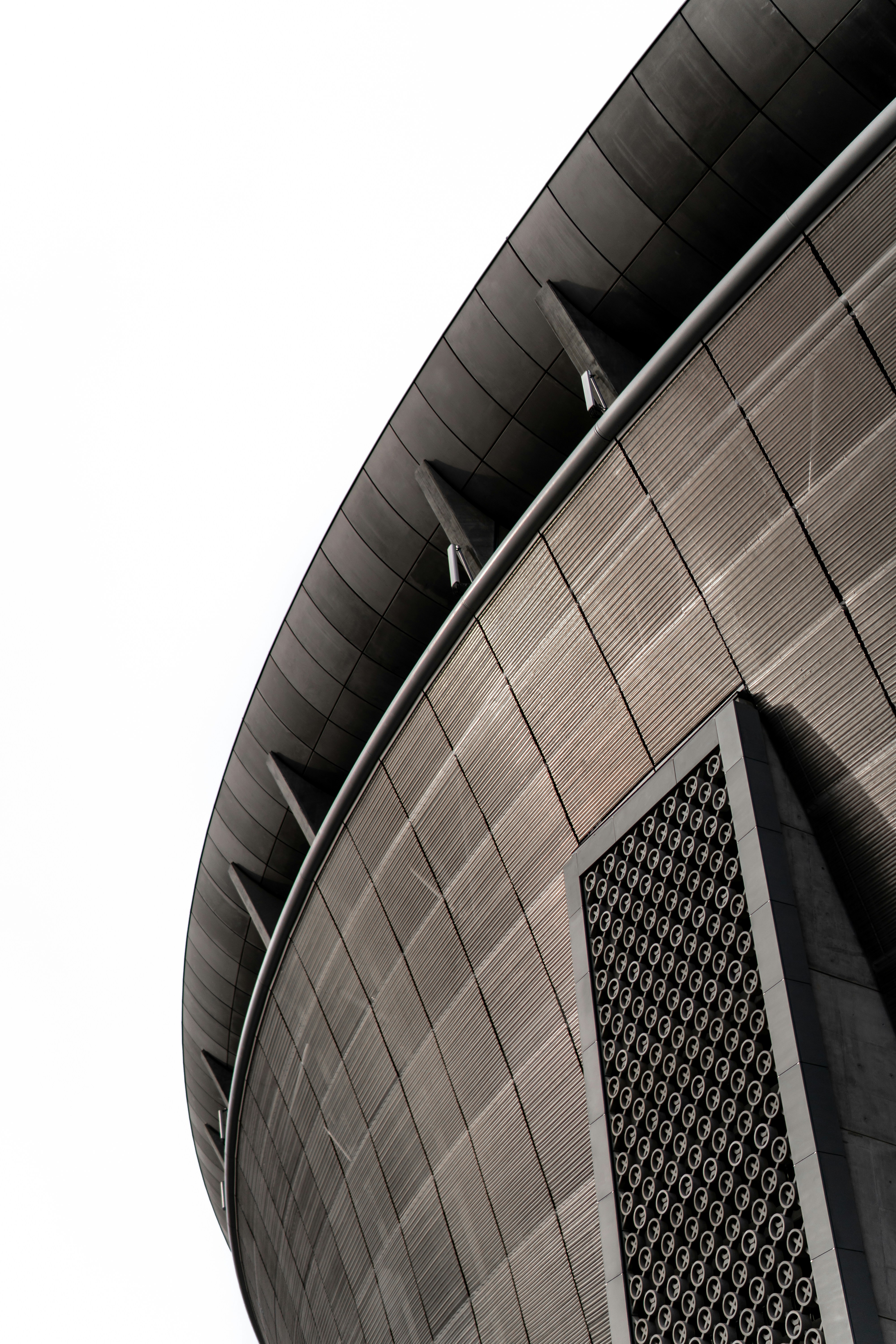 Close-up of a modern architectural structure featuring sleek lines and intricate patterns on its surface.