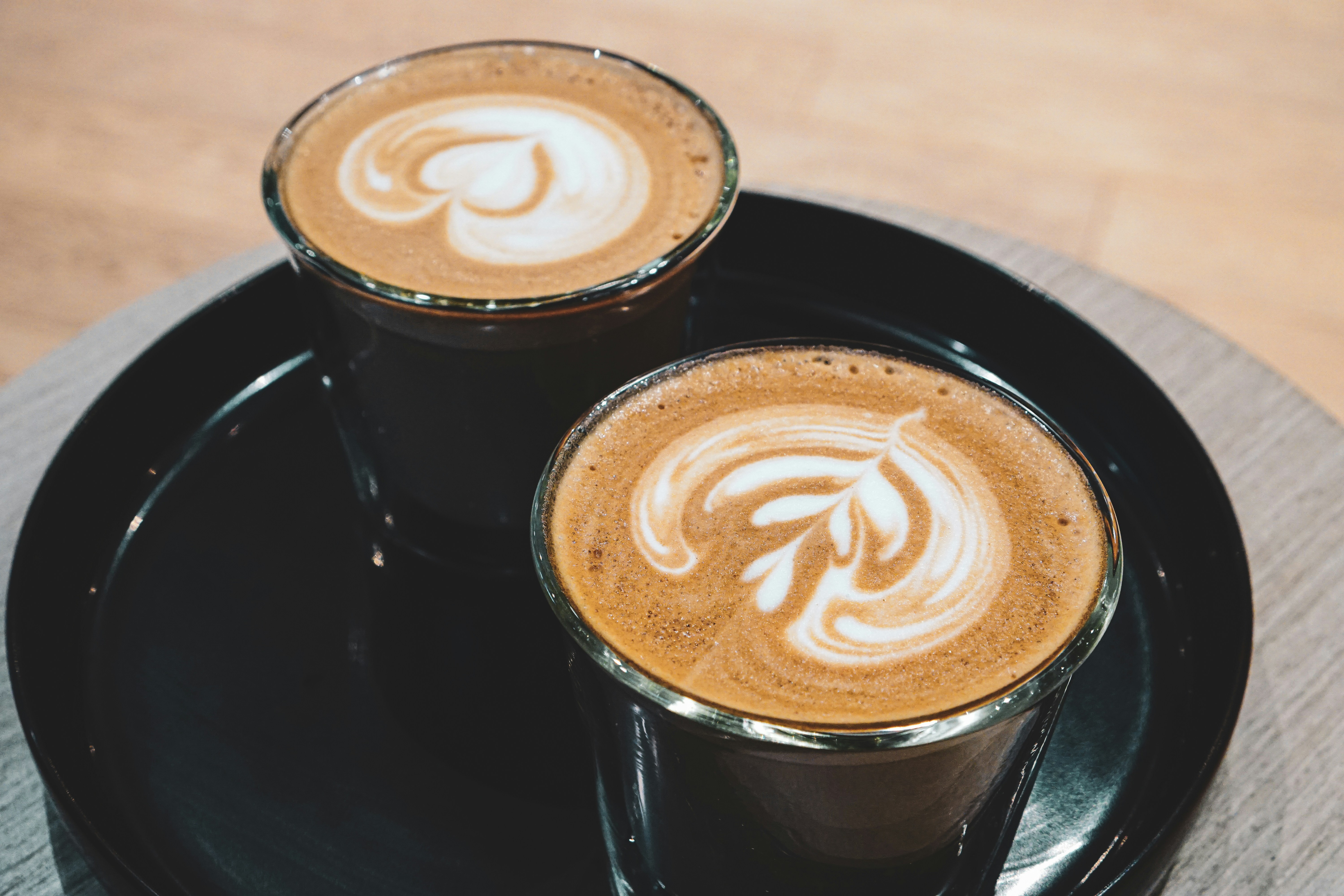 Duo Rosetta: Two Cappuccinos on a Matte Black Plate