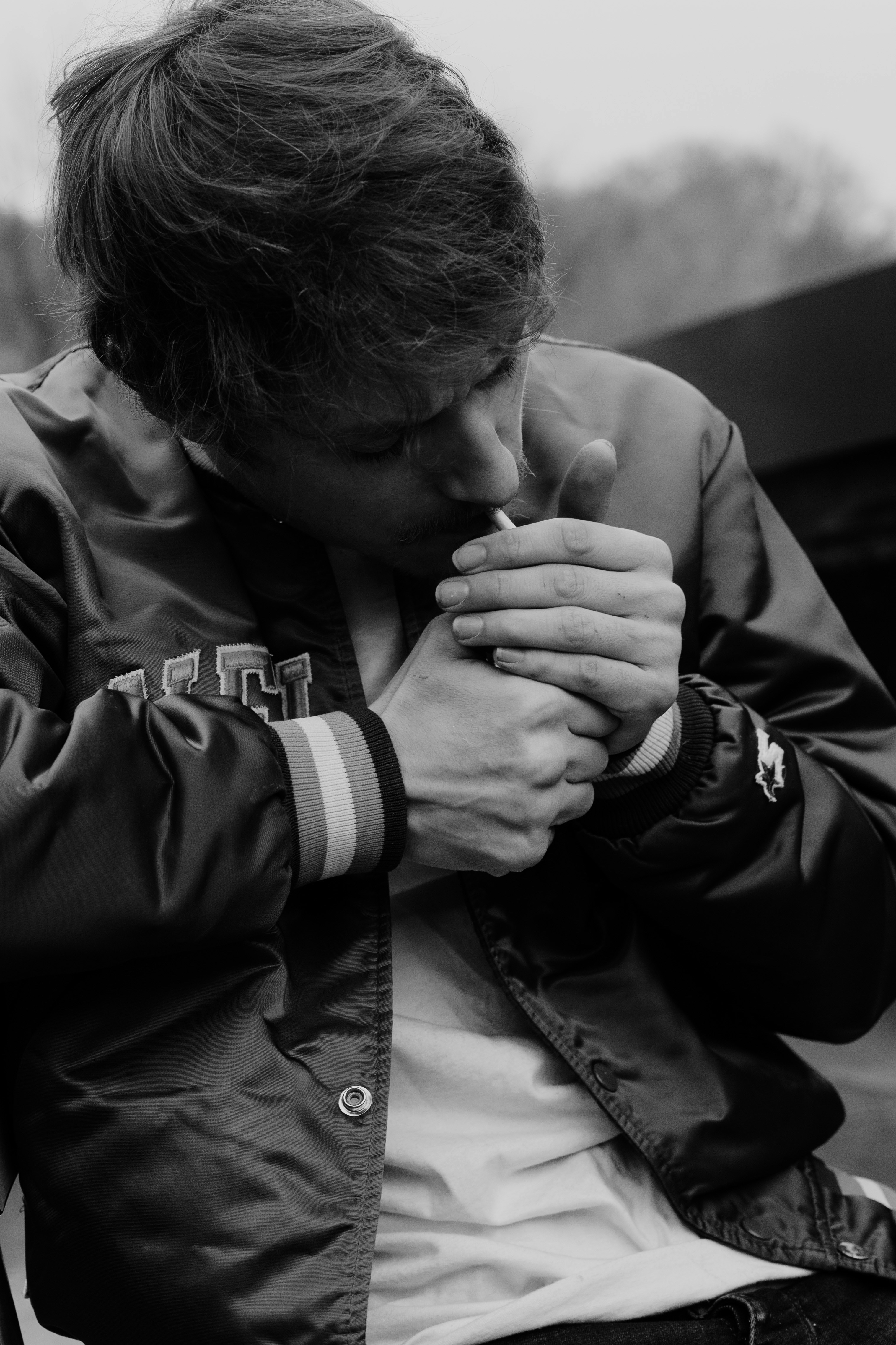 Monochrome Focus: The Quiet Gesture of a Man Lighting a Cigarette