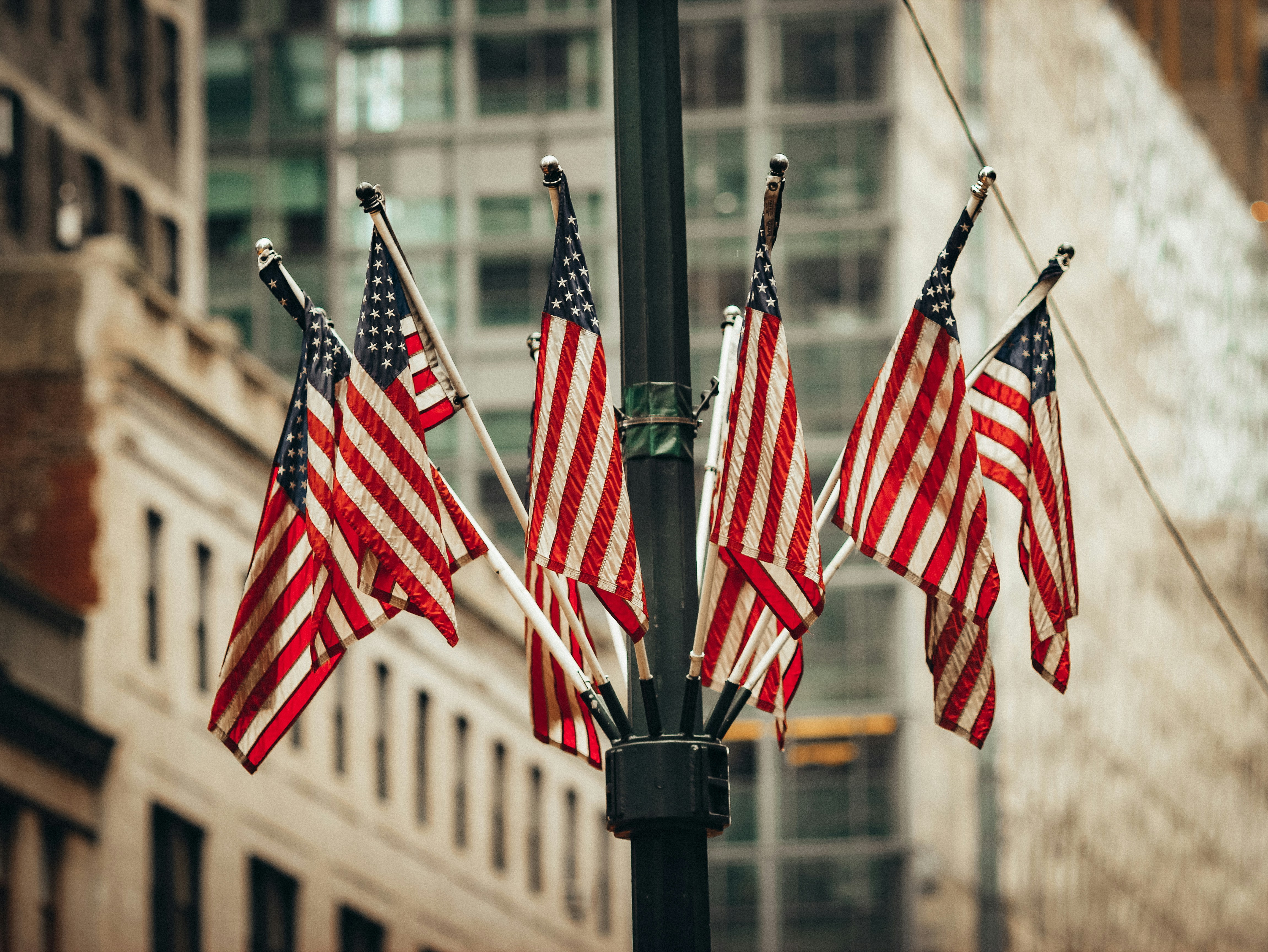 Urban Flagscape: Red, White, and Steel Framing a City Street