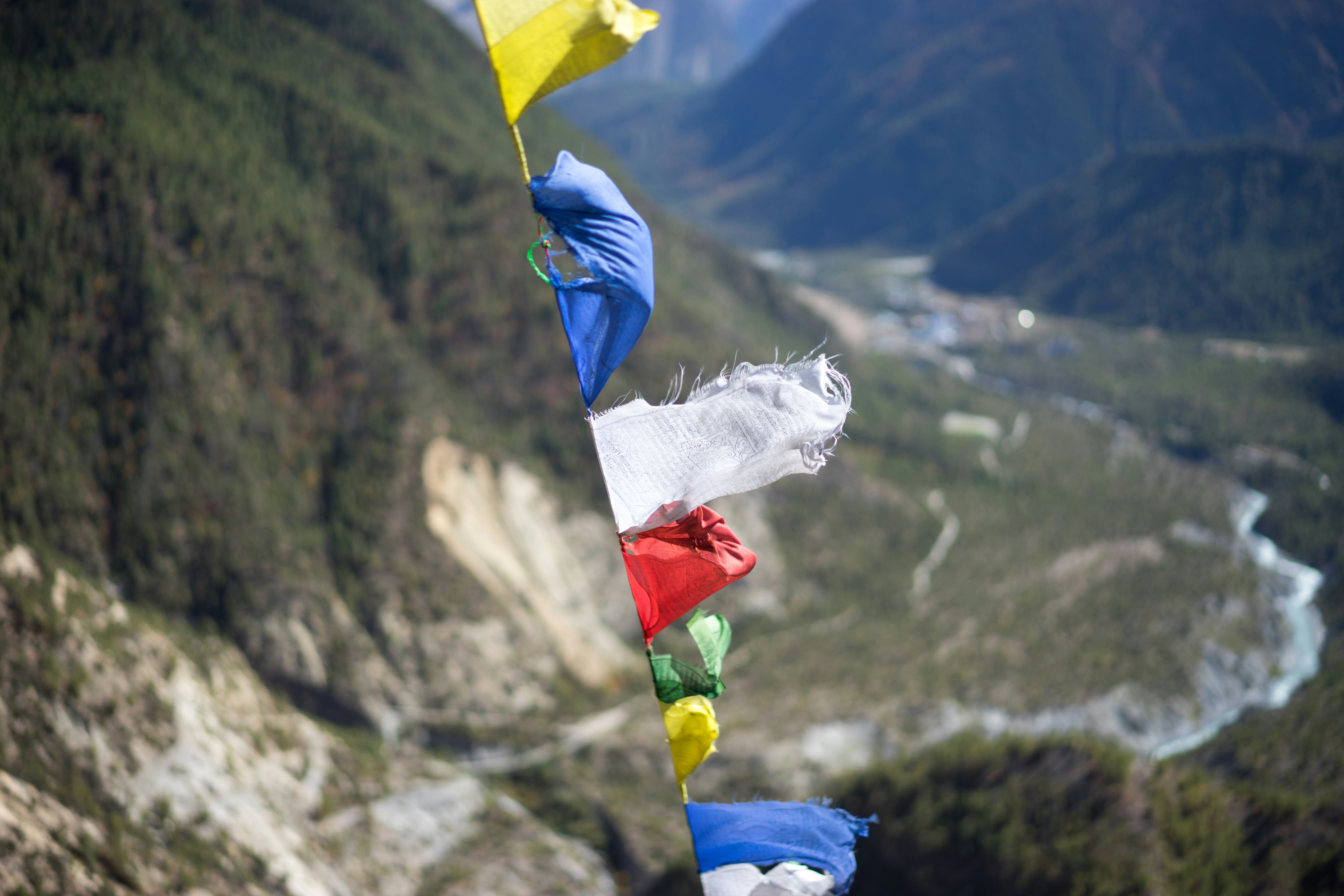 Colorful Prayer Flags Framing a Mountain Valley