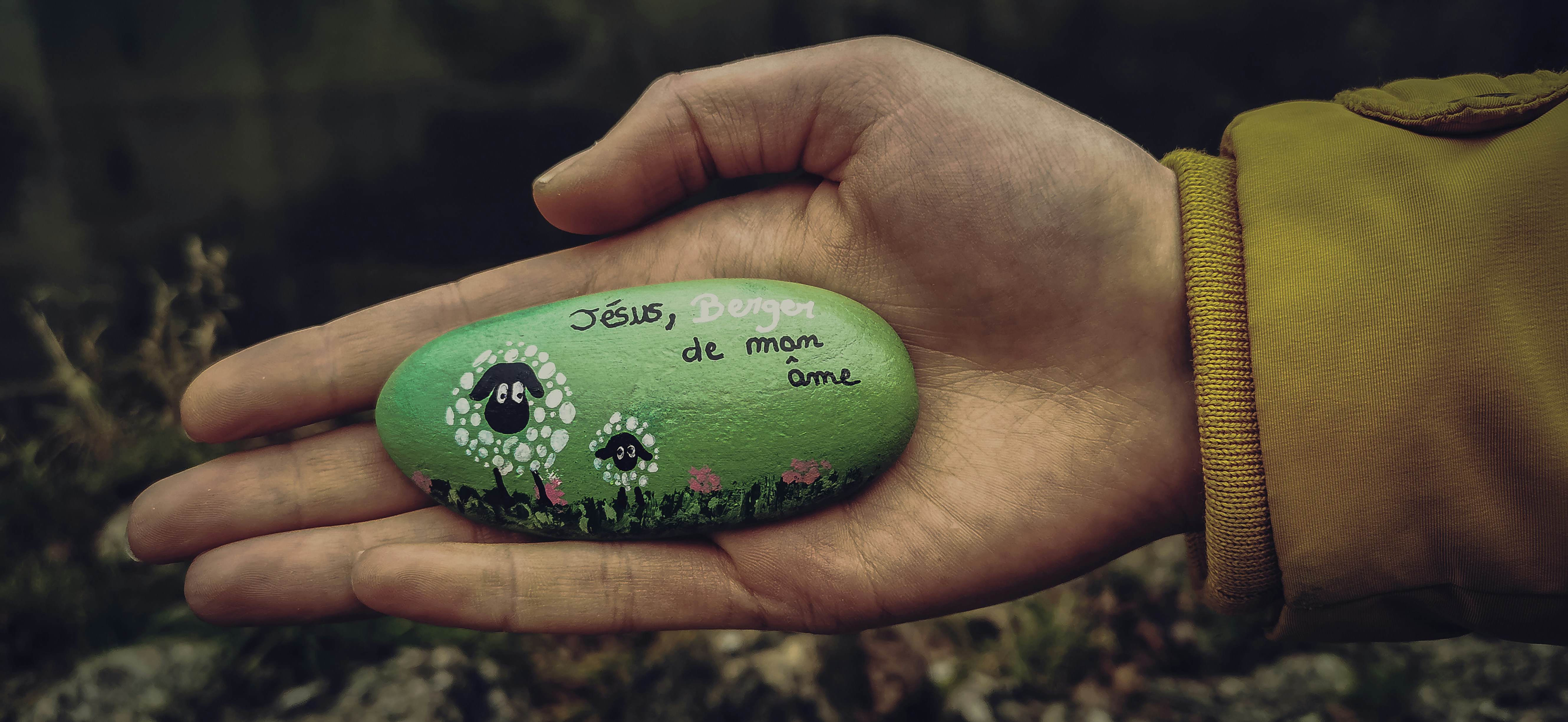 Green Pebble Keepsake: a tiny mural cradled in a sunlit palm