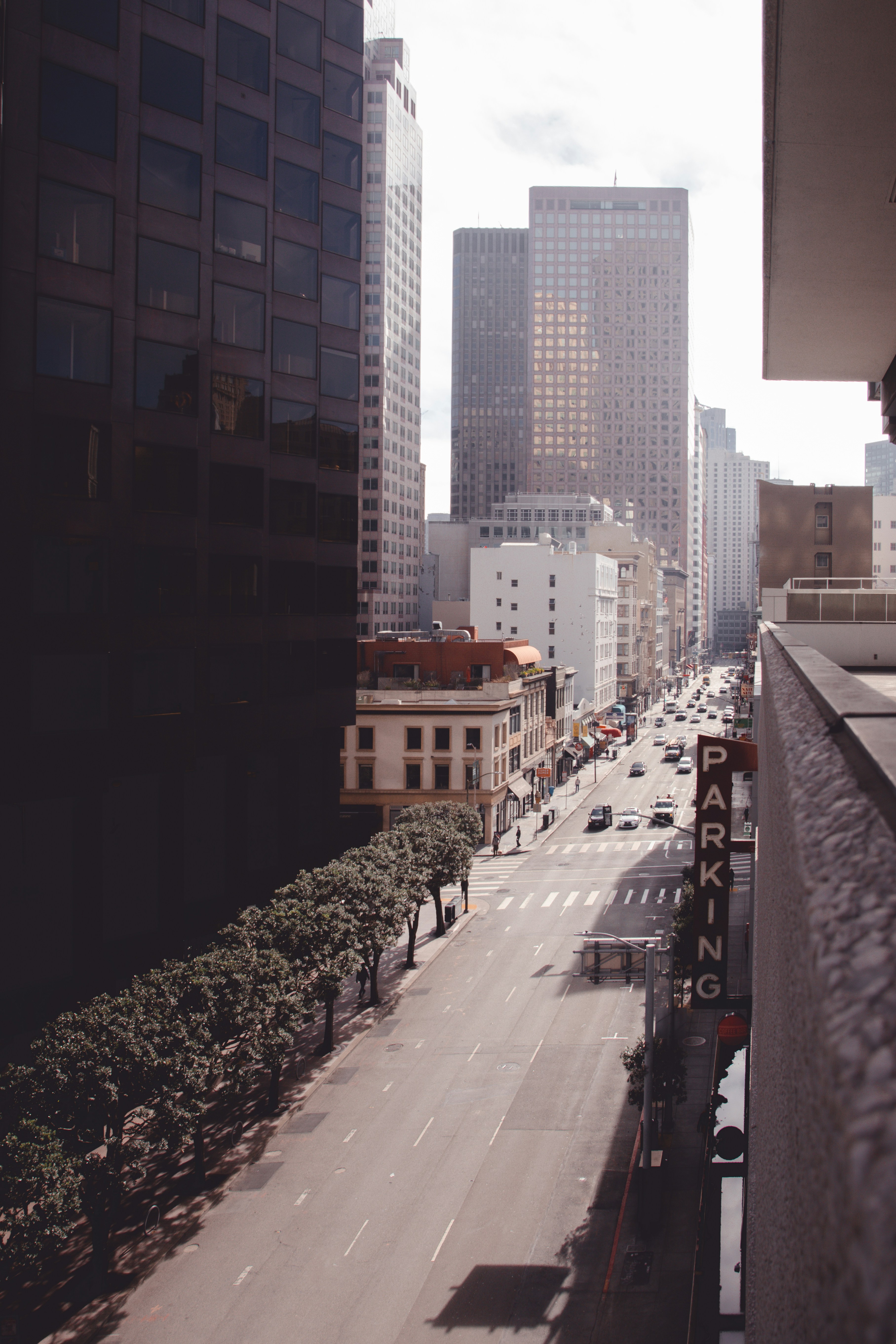 People walking on sidewalk near high rise buildings during daytime ...