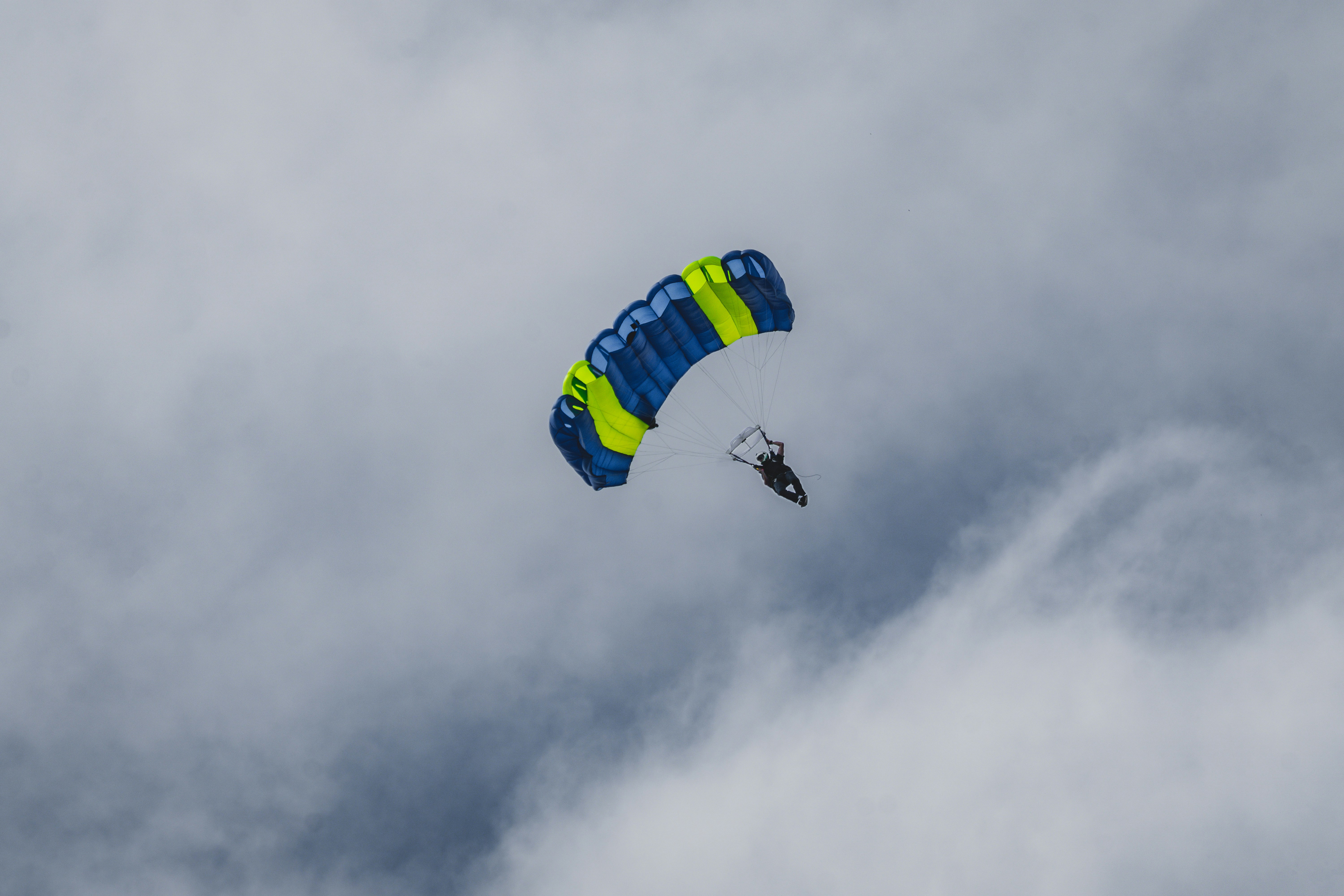Person in yellow parachute under white clouds during daytime photo ...