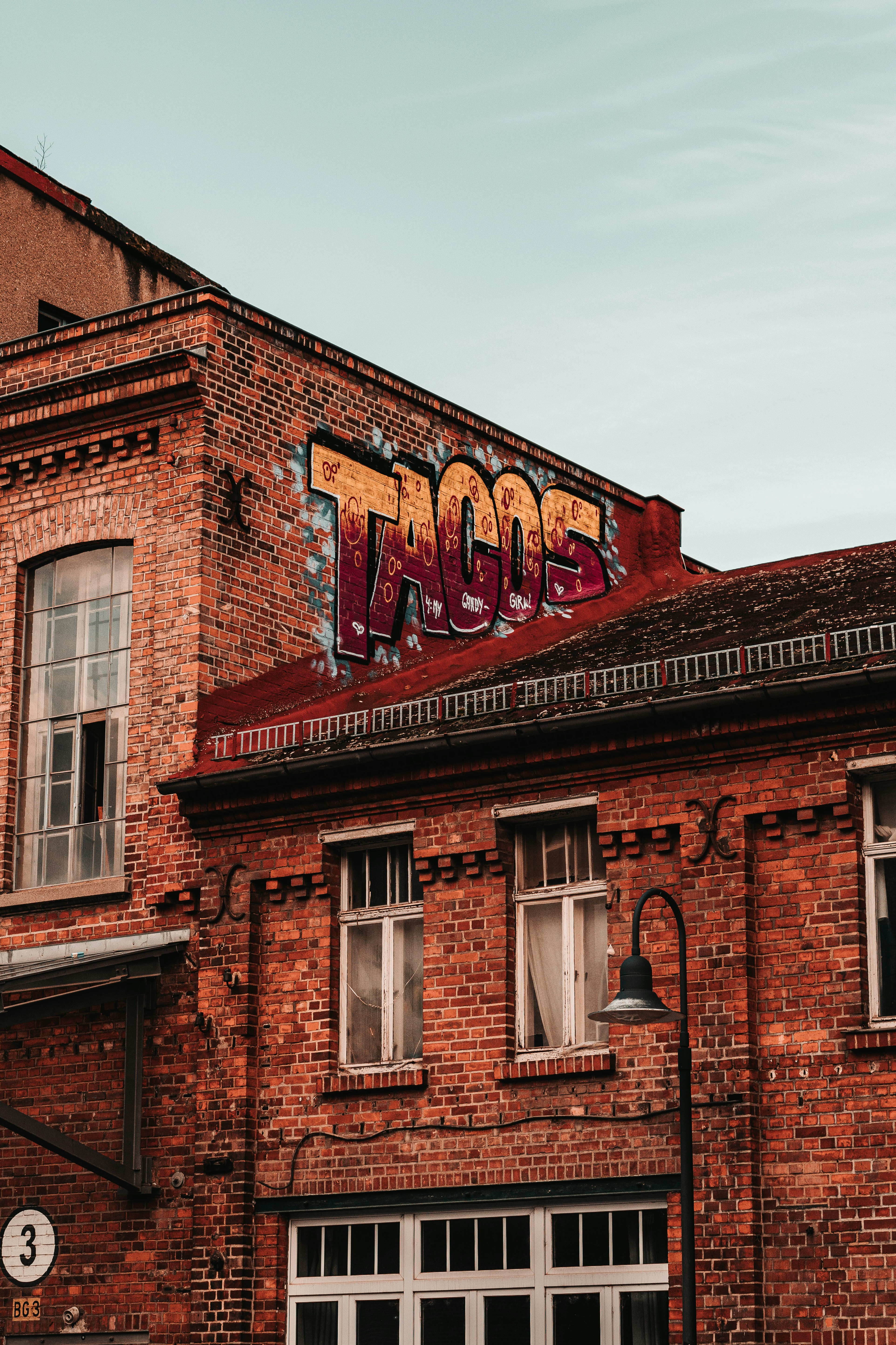 Graffiti Crown Over a Red-Brick Facade