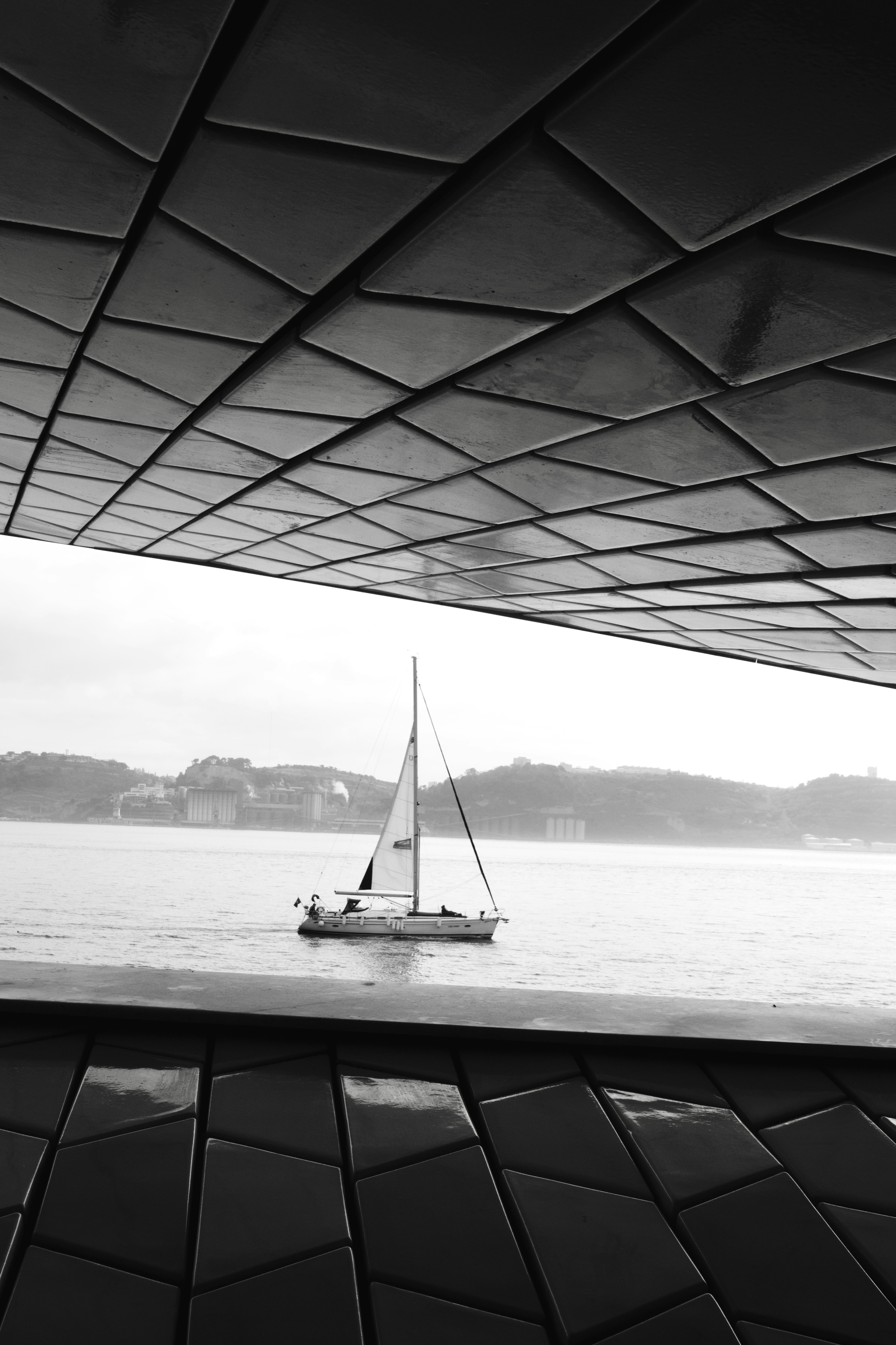 grayscale photo of sailboat on sea