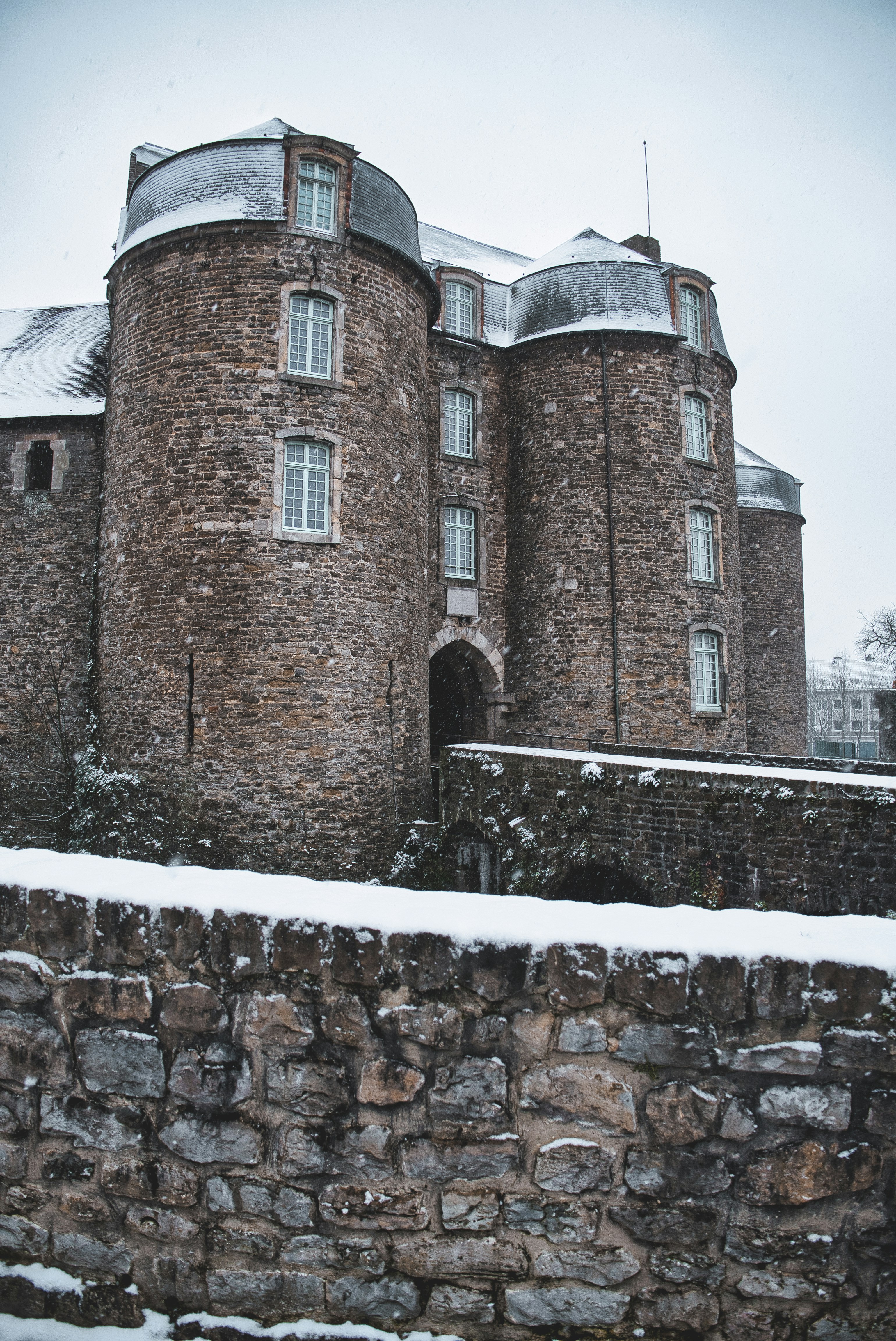 Winter Keep: Snow-Dusted Brick Towers Guard an Arched Gateway