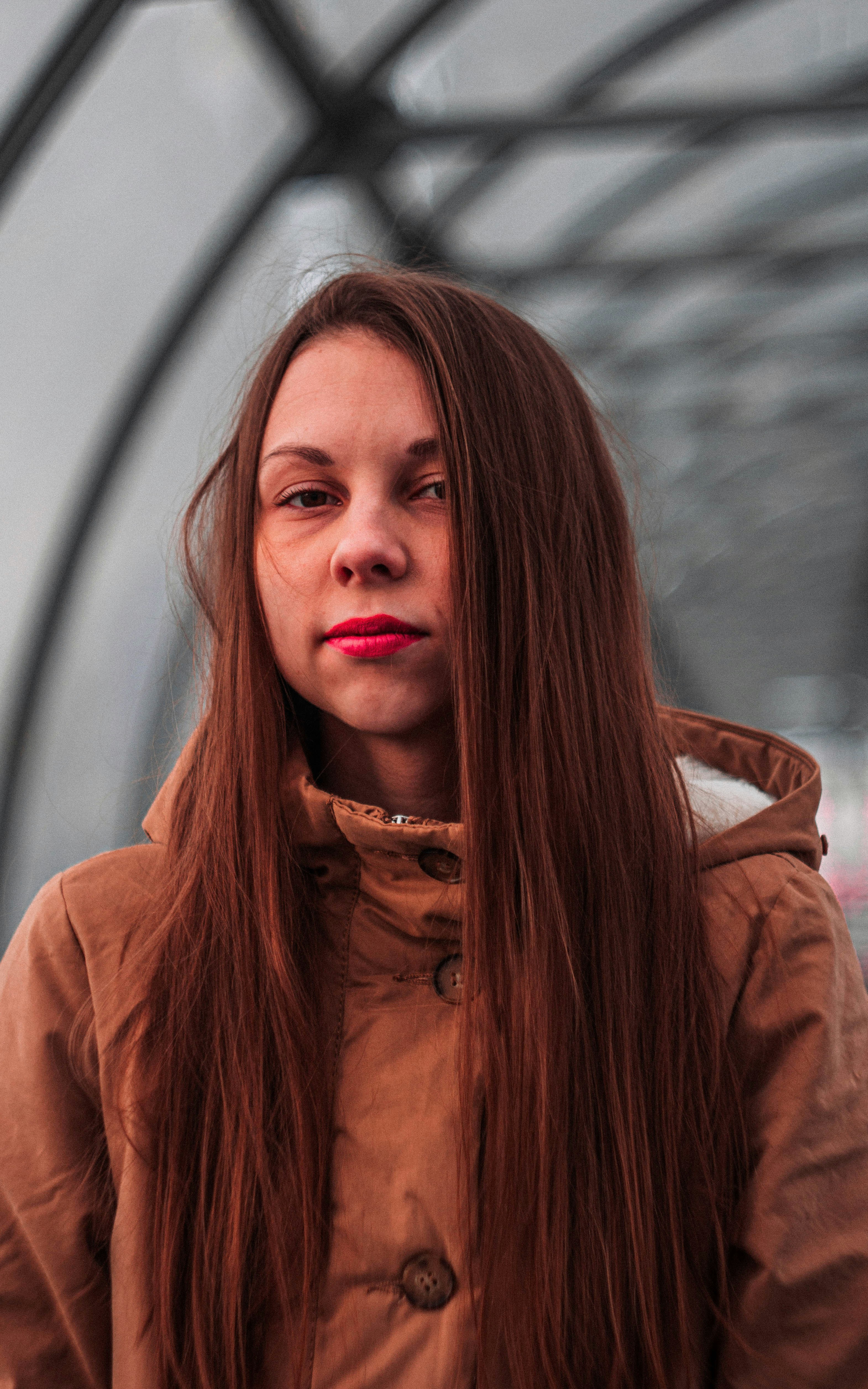 Red Lip in a Glass Arc: Portrait Beneath Transit Curves