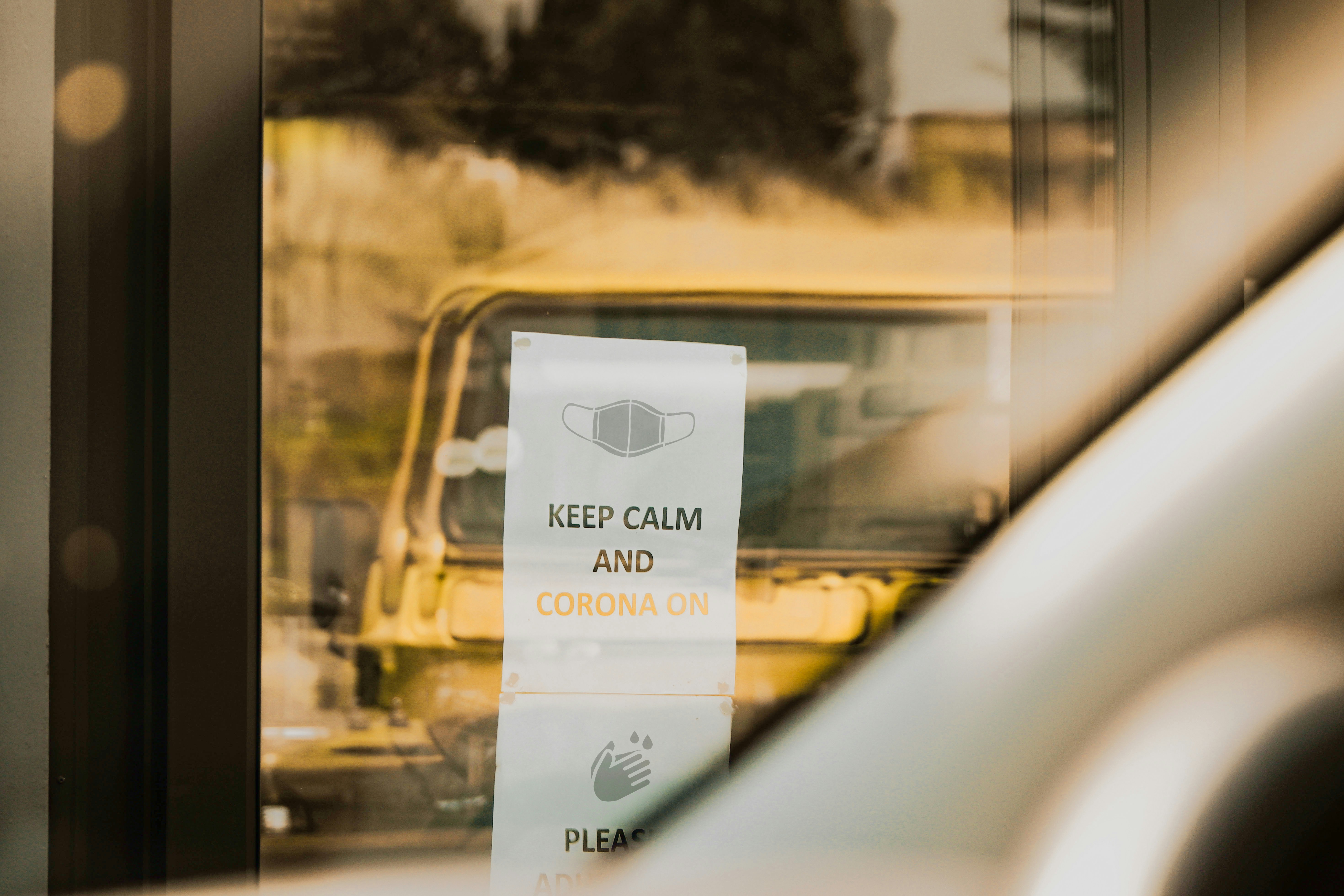 Keep Calm and Corona On: A Window Sign Framed by Golden Street Light