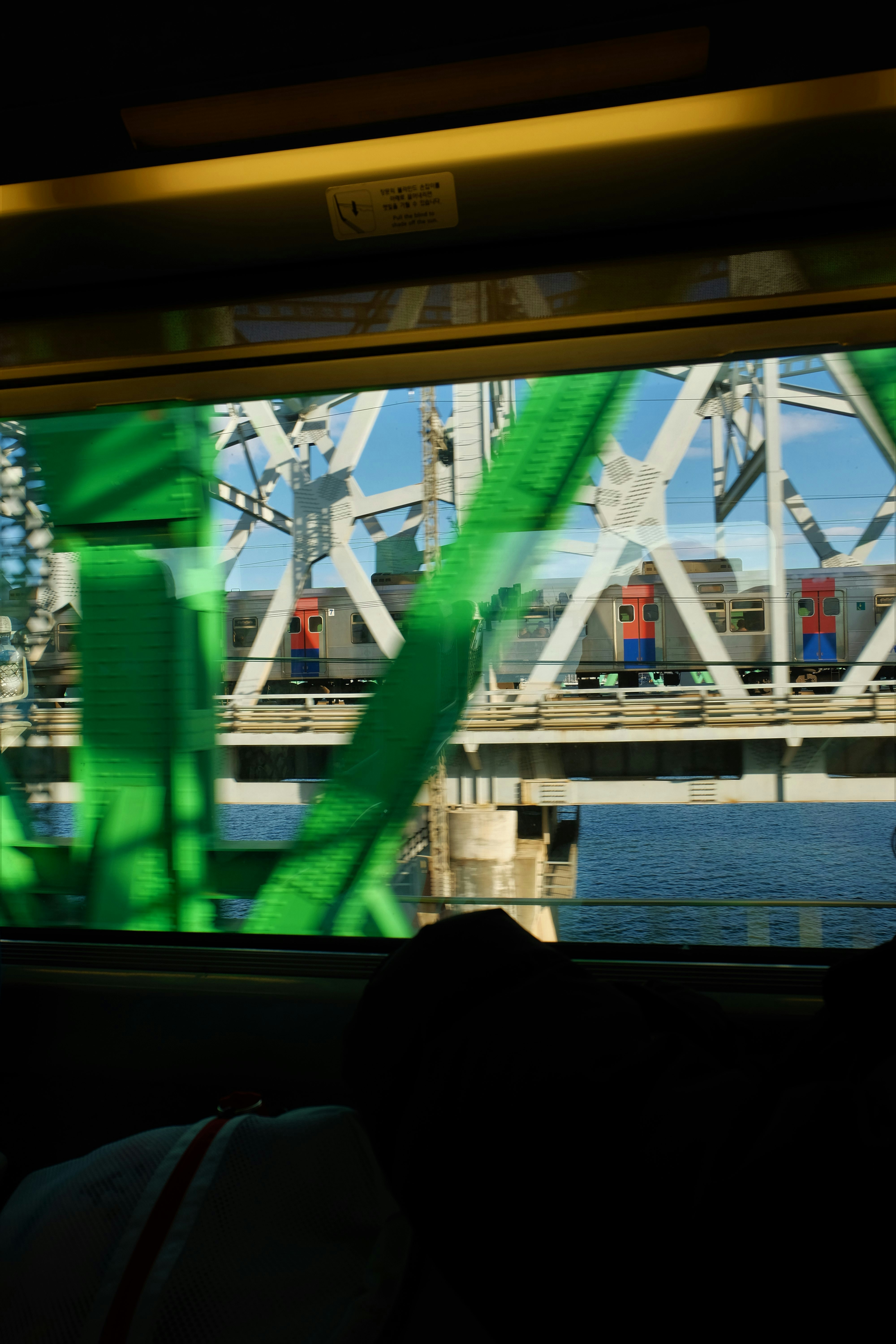 Green Beam of Transit: Framed Structural Crossings Outside a Train Car