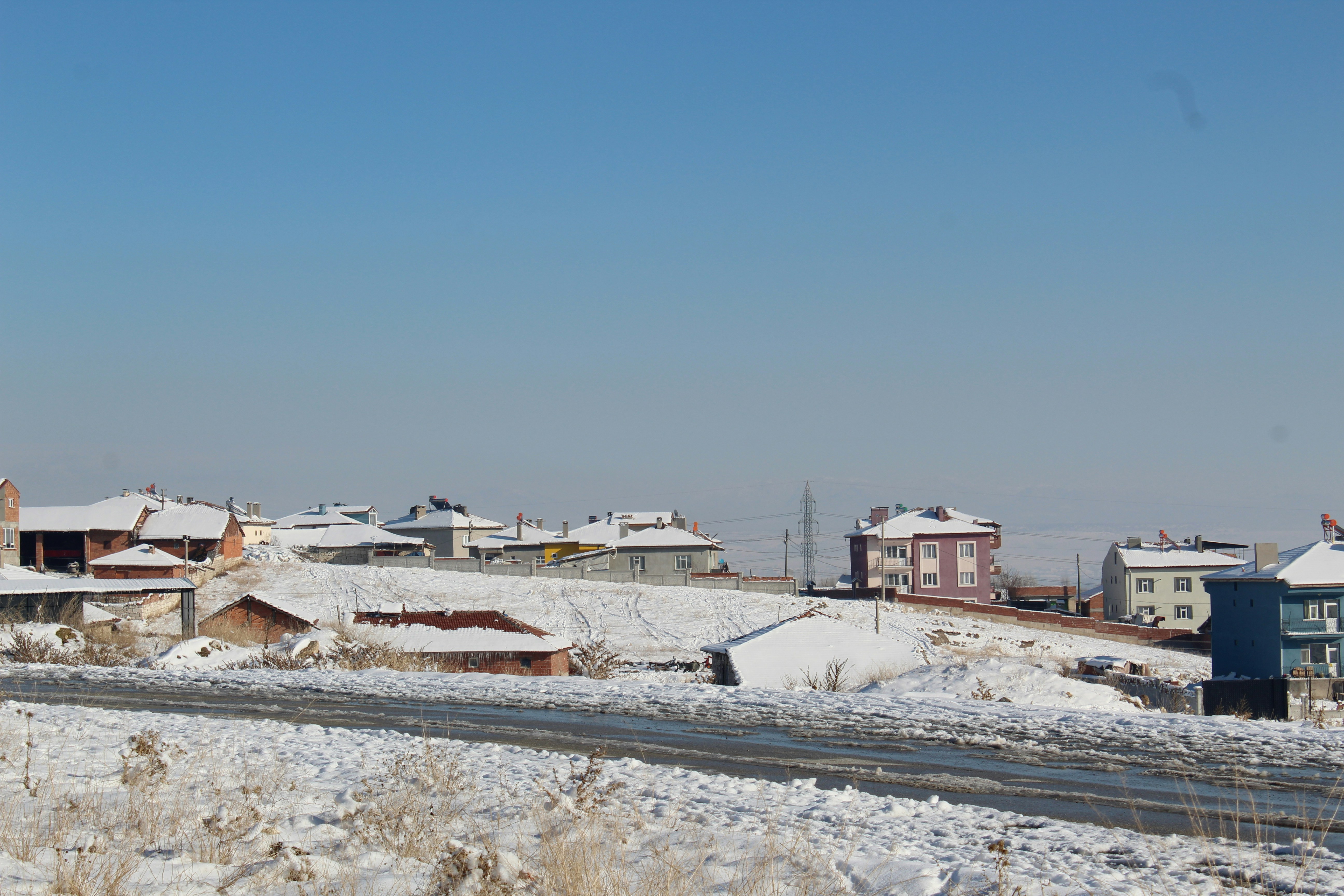 Snowbound Village Under A Clear Blue Noon