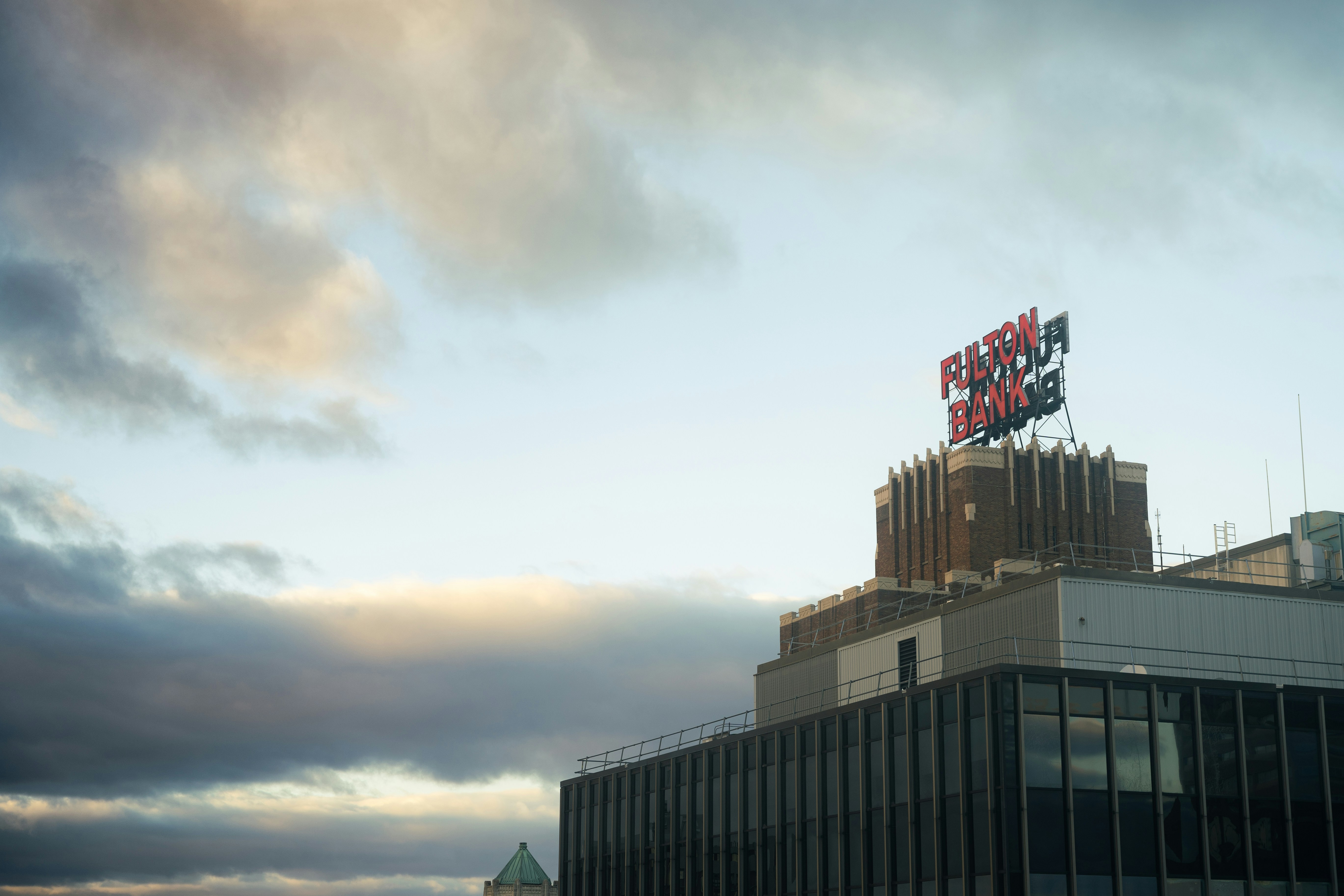 Top Sign Crown: Rooftop Neon Over a Glass Skyline at Dusk