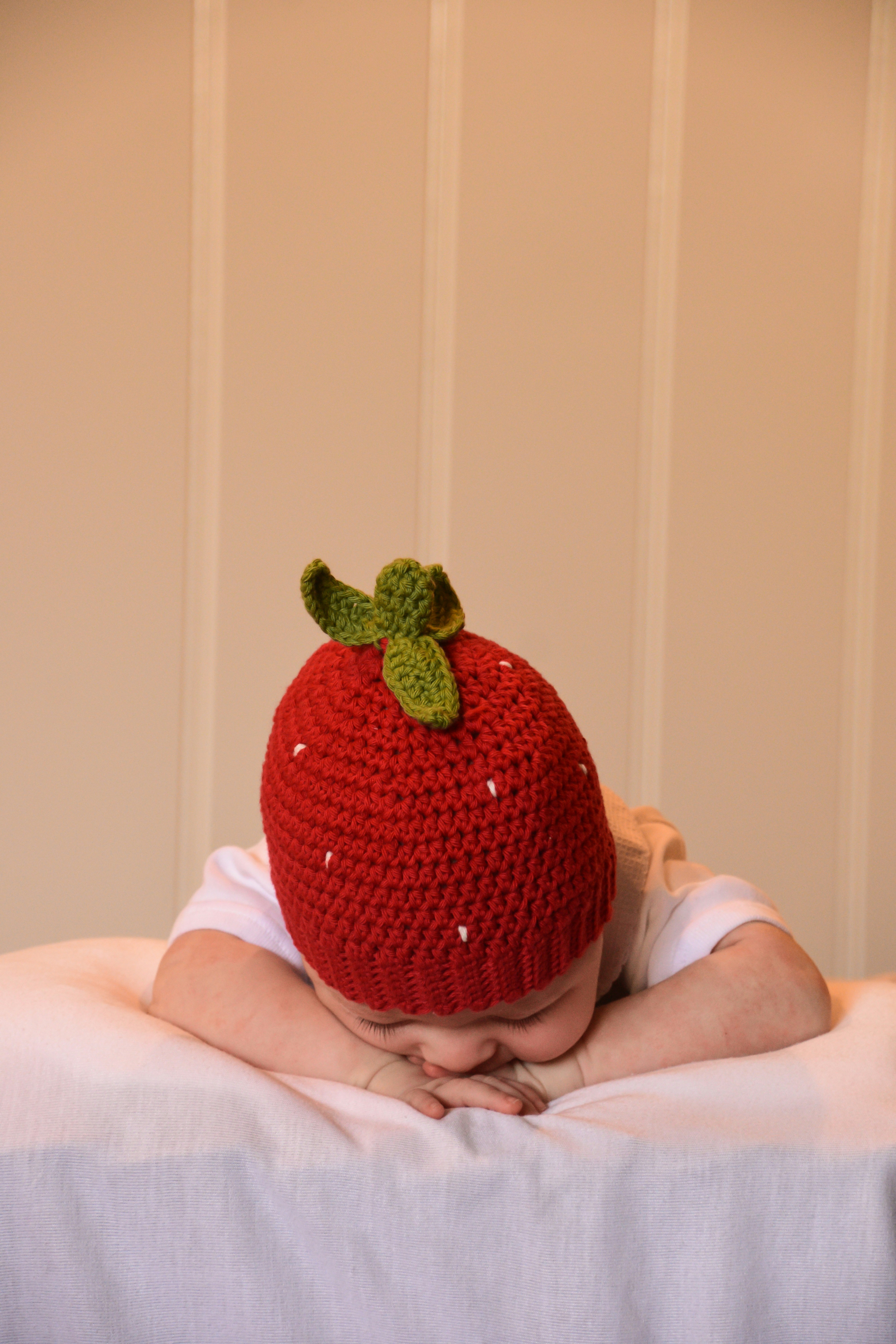 Crocheted Strawberry Hat Dream: A Sleepy Baby Portrait