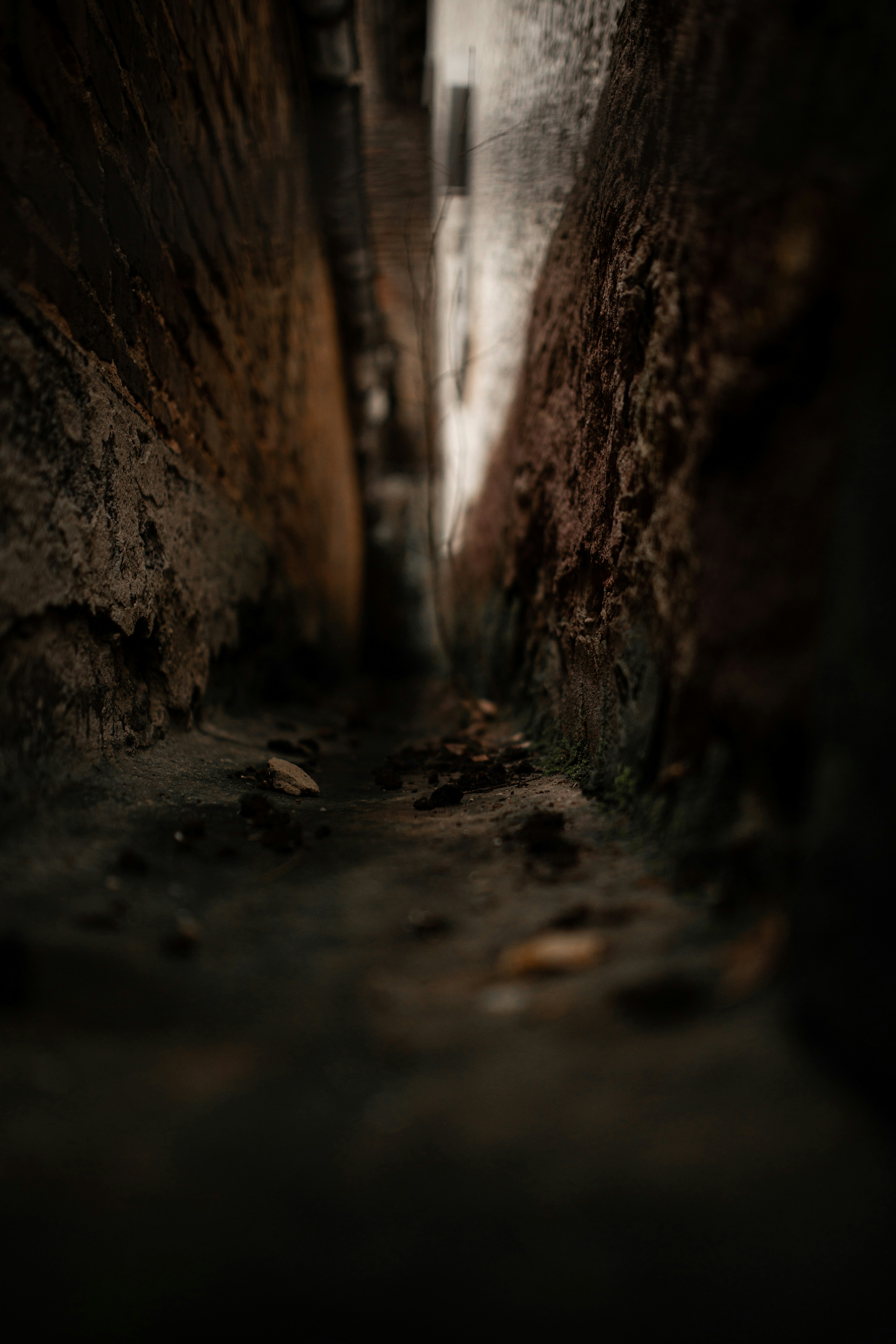 A Sliver of Light Between Weathered Bricks