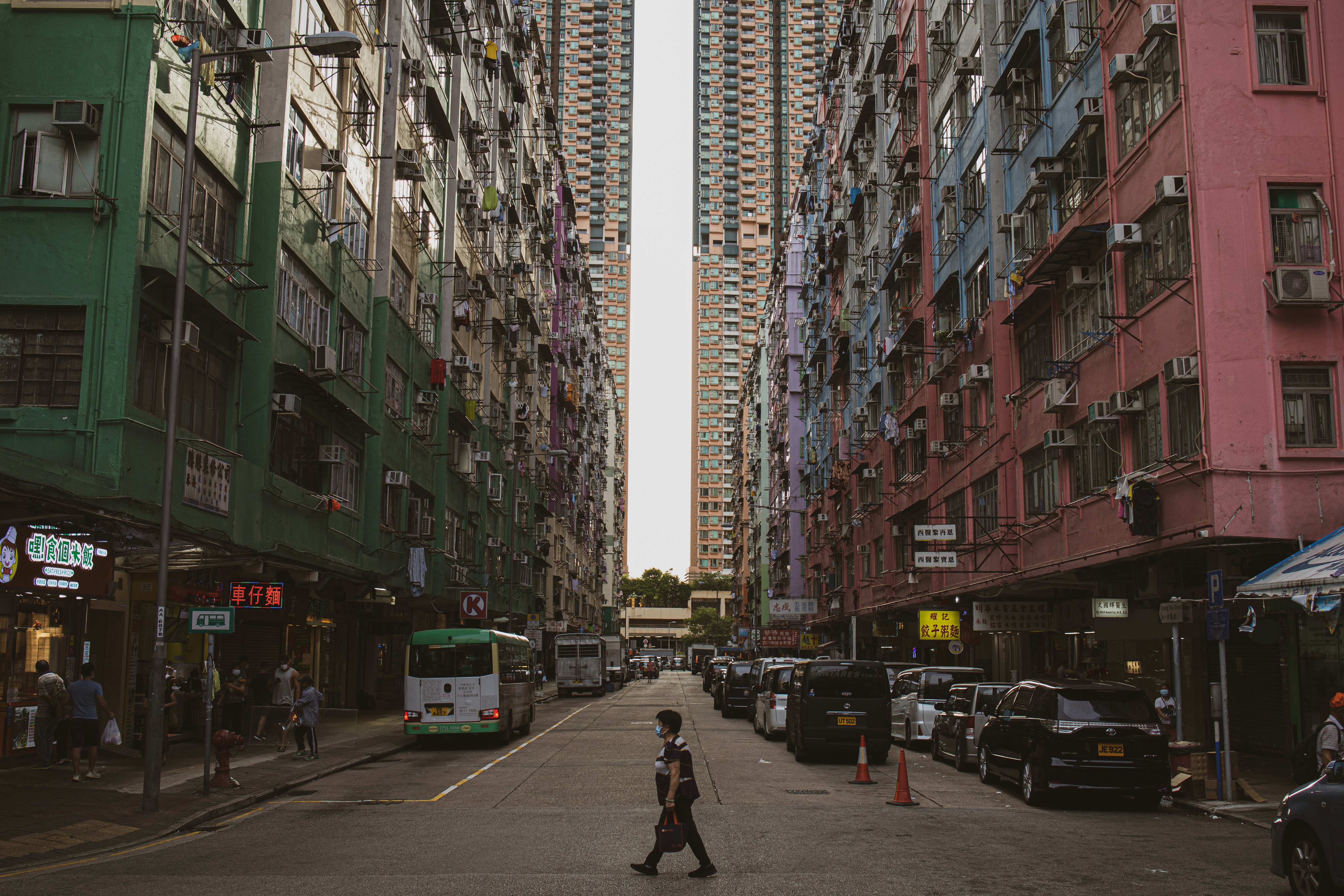 people walking on street between high rise buildings during daytime