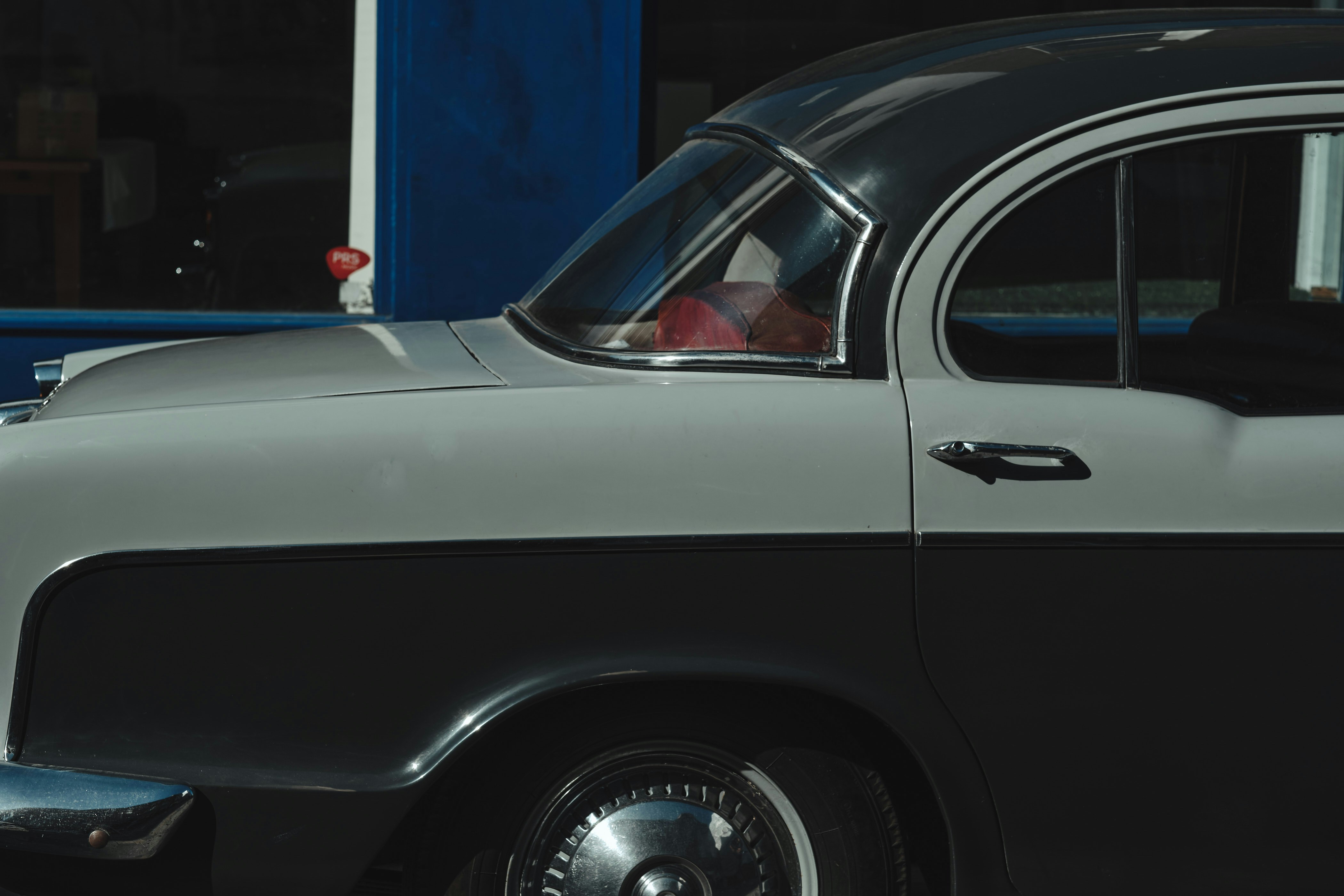 silver car parked near blue building