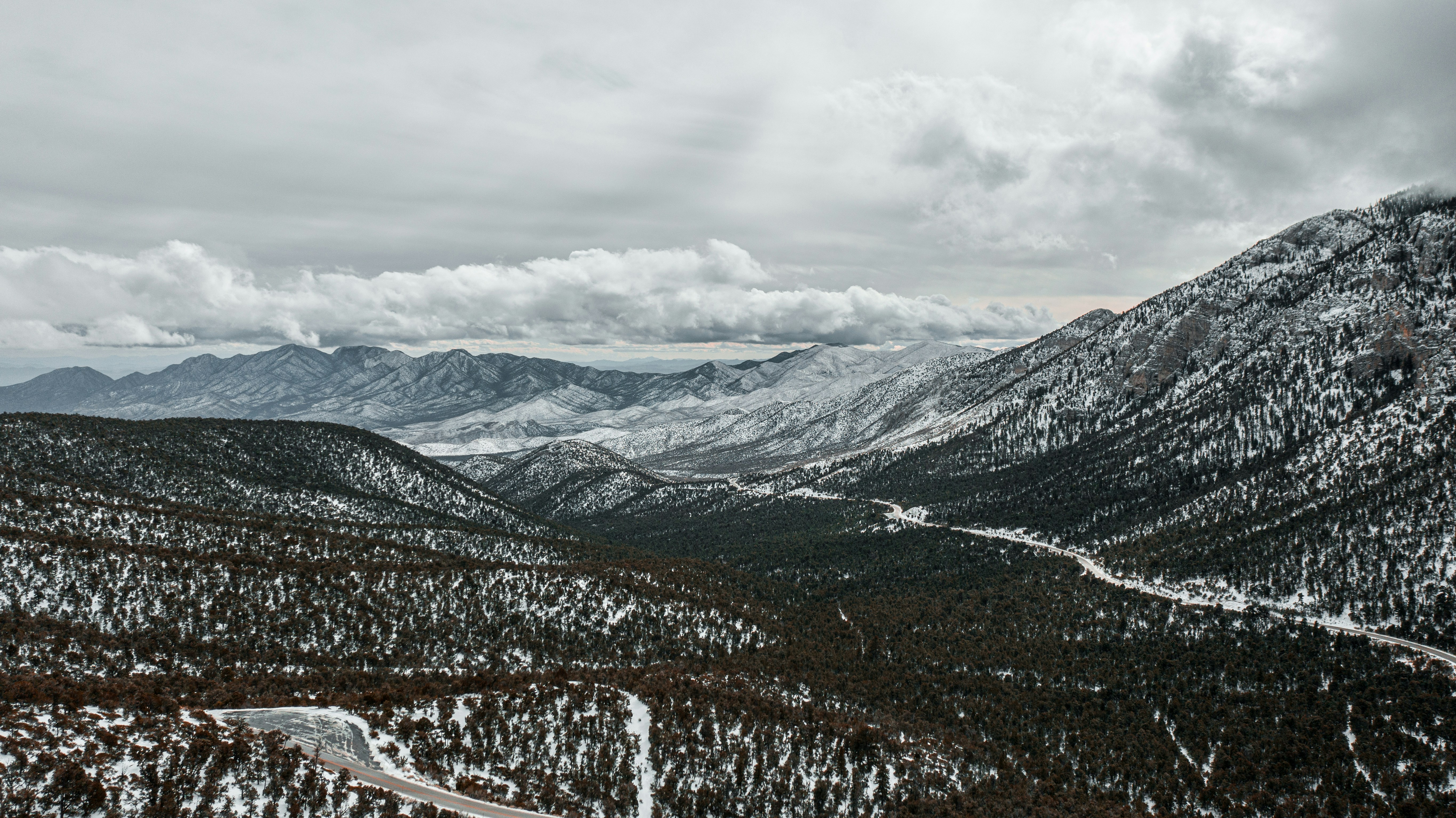 Snow covered mountains under cloudy sky during daytime photo – Free ...