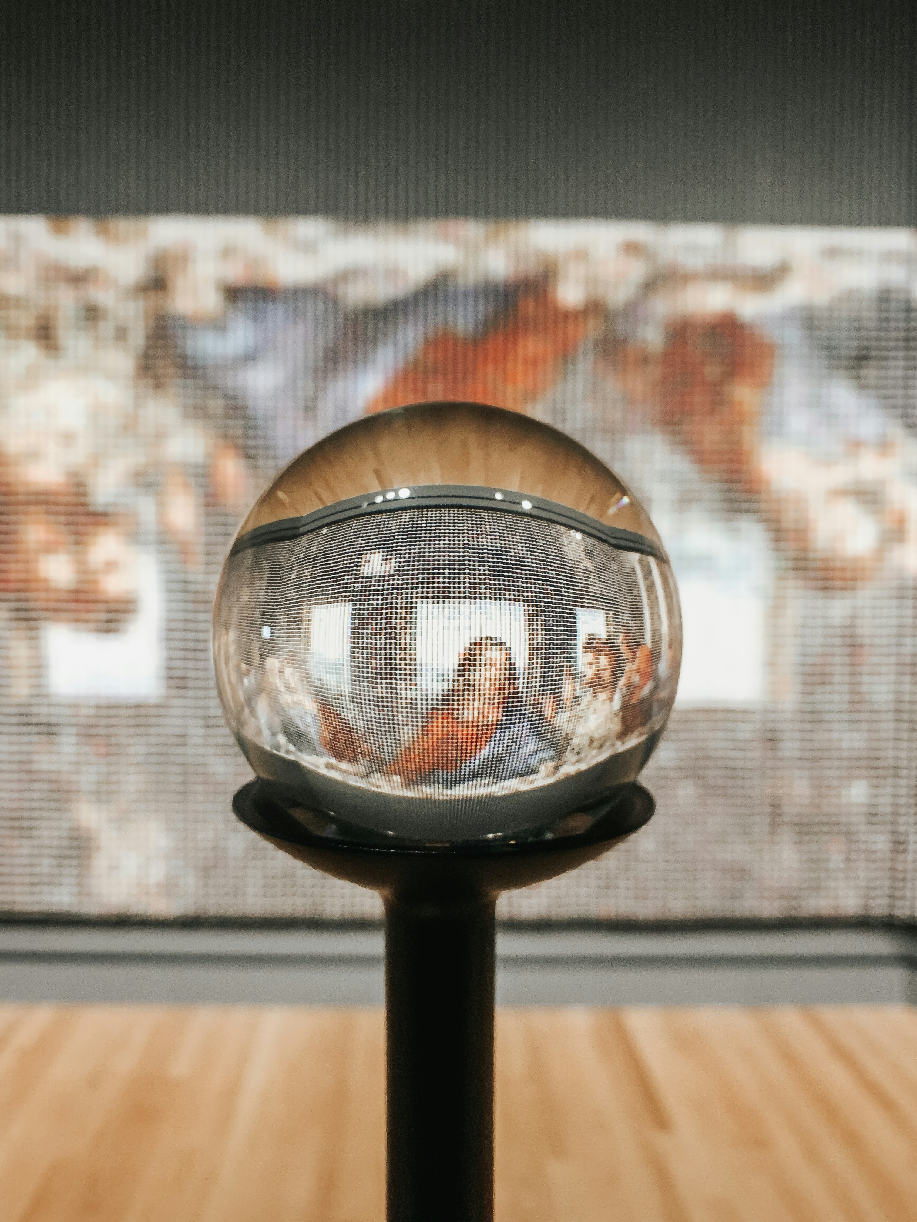 Reflections in a Crystal Sphere: People and Gallery Behind a Glass Orb