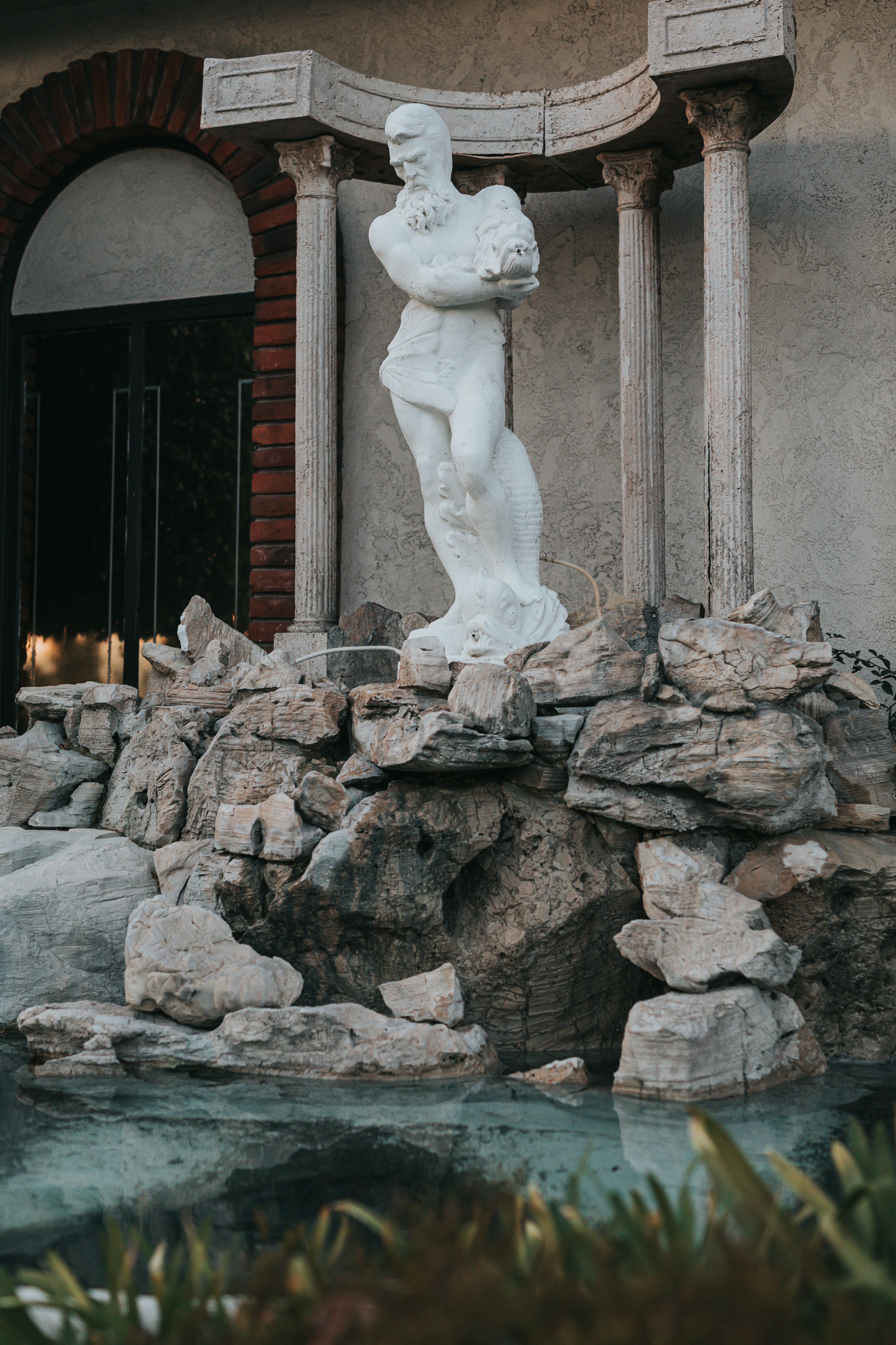 Stone Sentinel Over a Rock-Fed Fountain