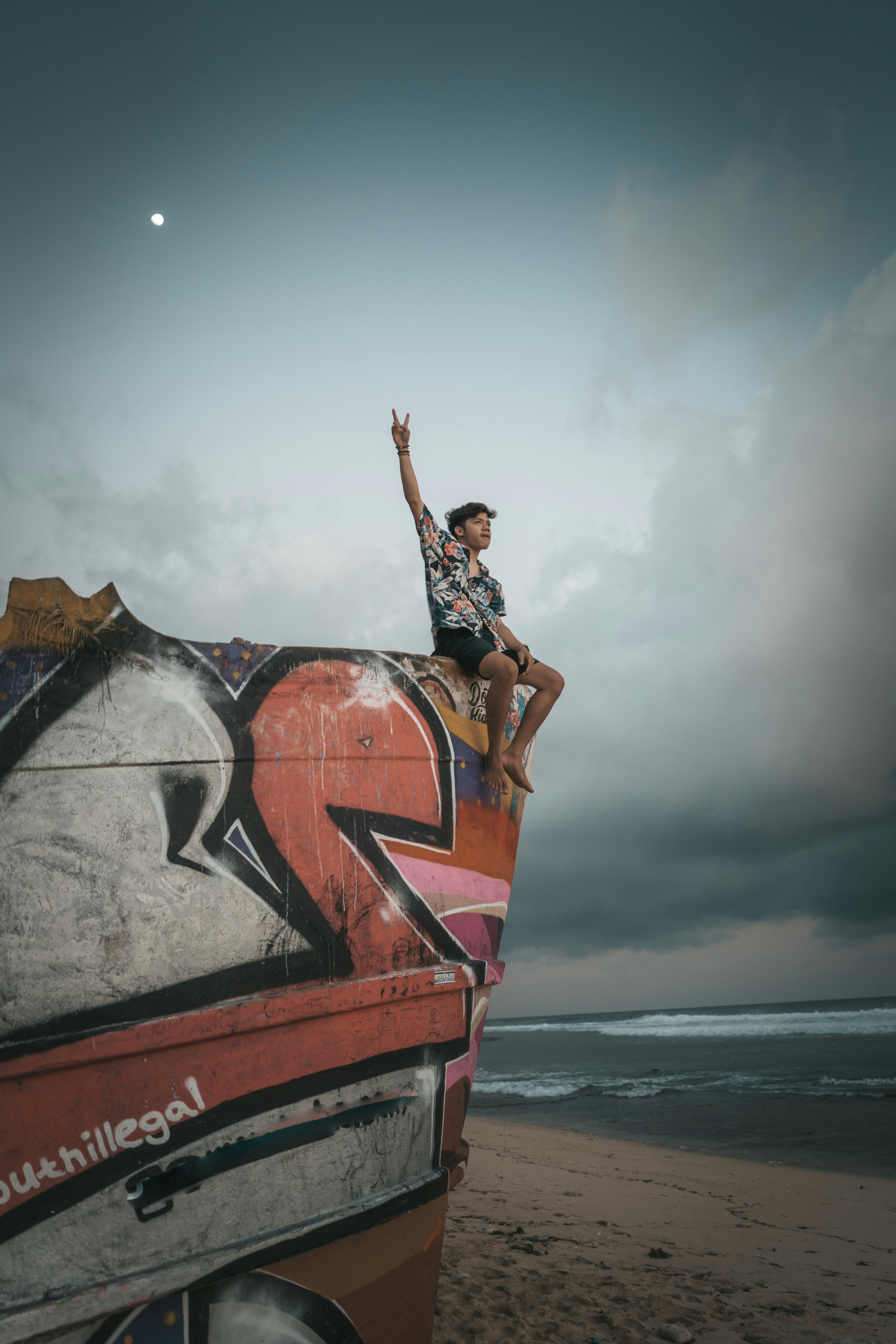 woman in brown leather jacket sitting on red and white wooden boat