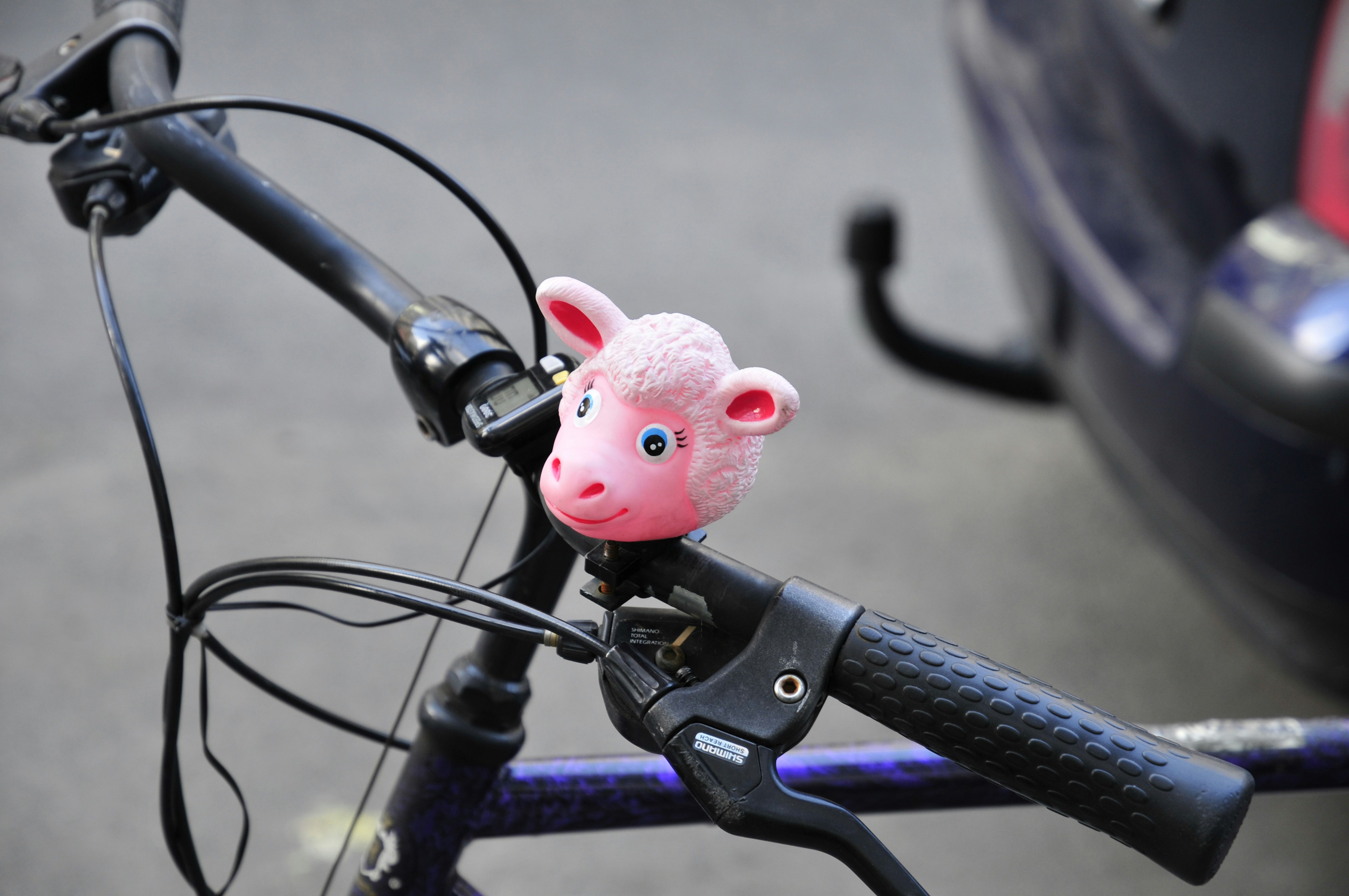 Whimsical Pink Piglet Adorns a City Bike Handlebar