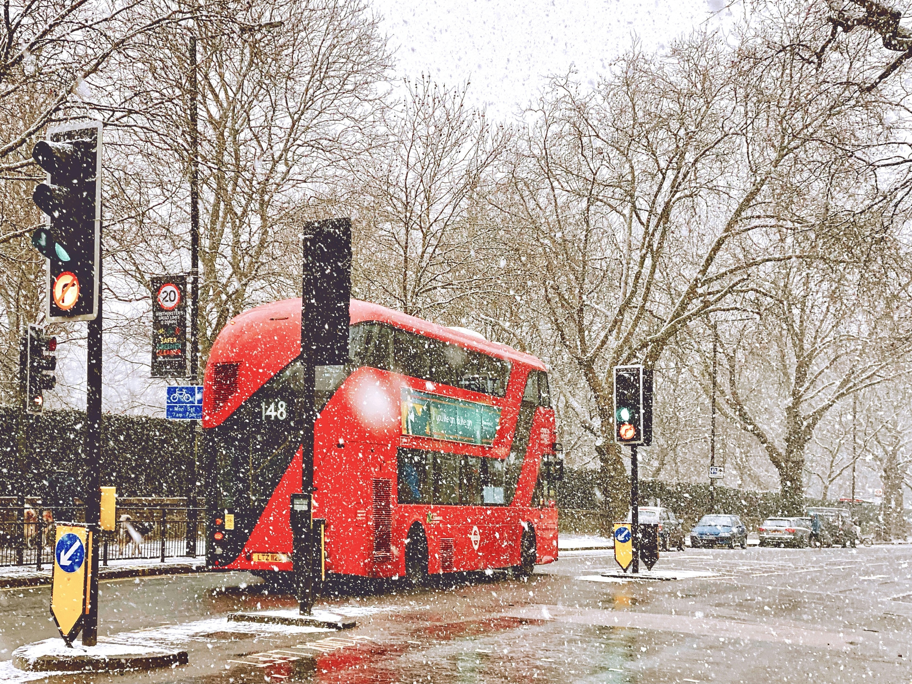 Crimson Double-Decker on a Snow-Dusted City Street