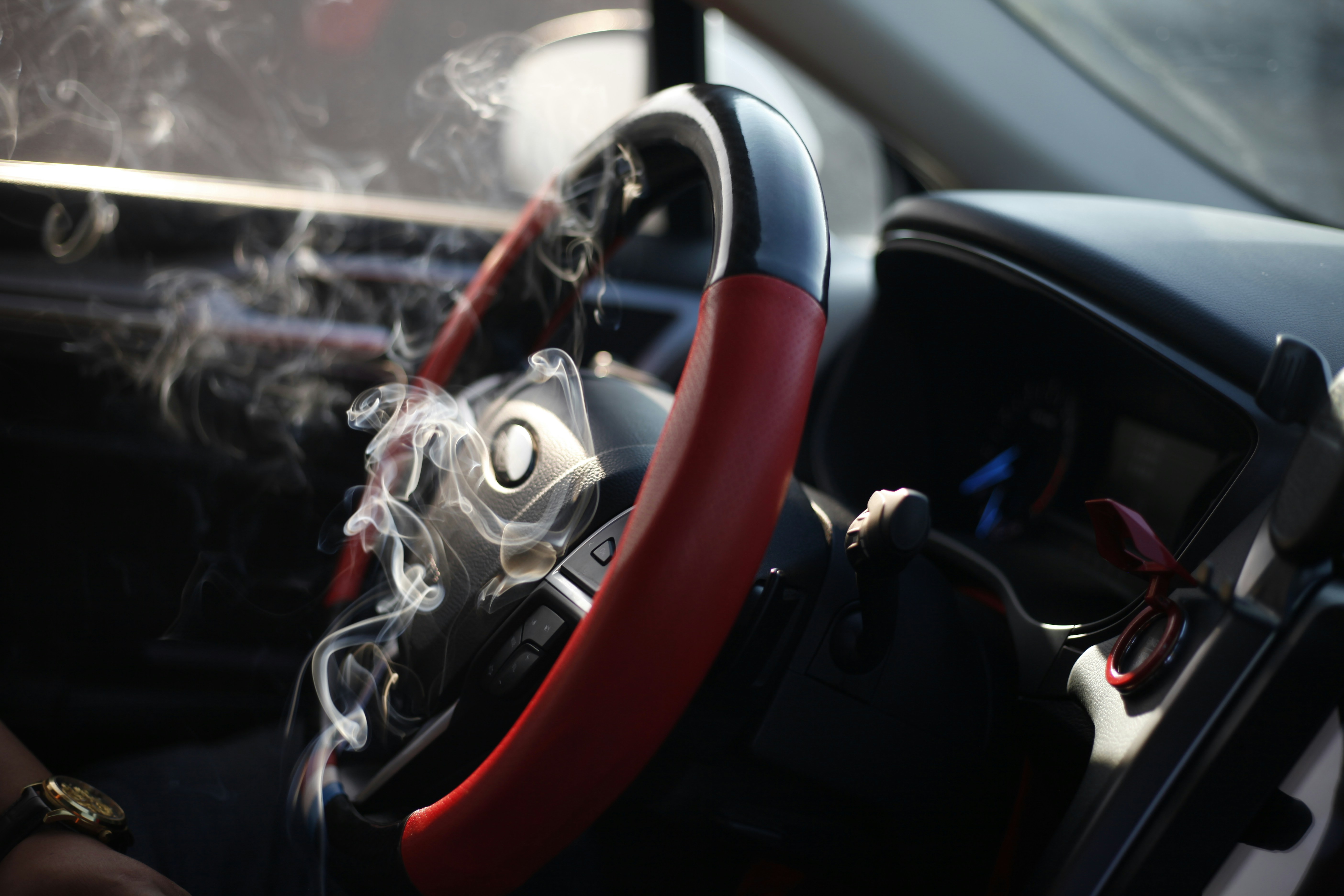Mist over the Red-Wrapped Wheel: A Quiet Car Cabin Moment