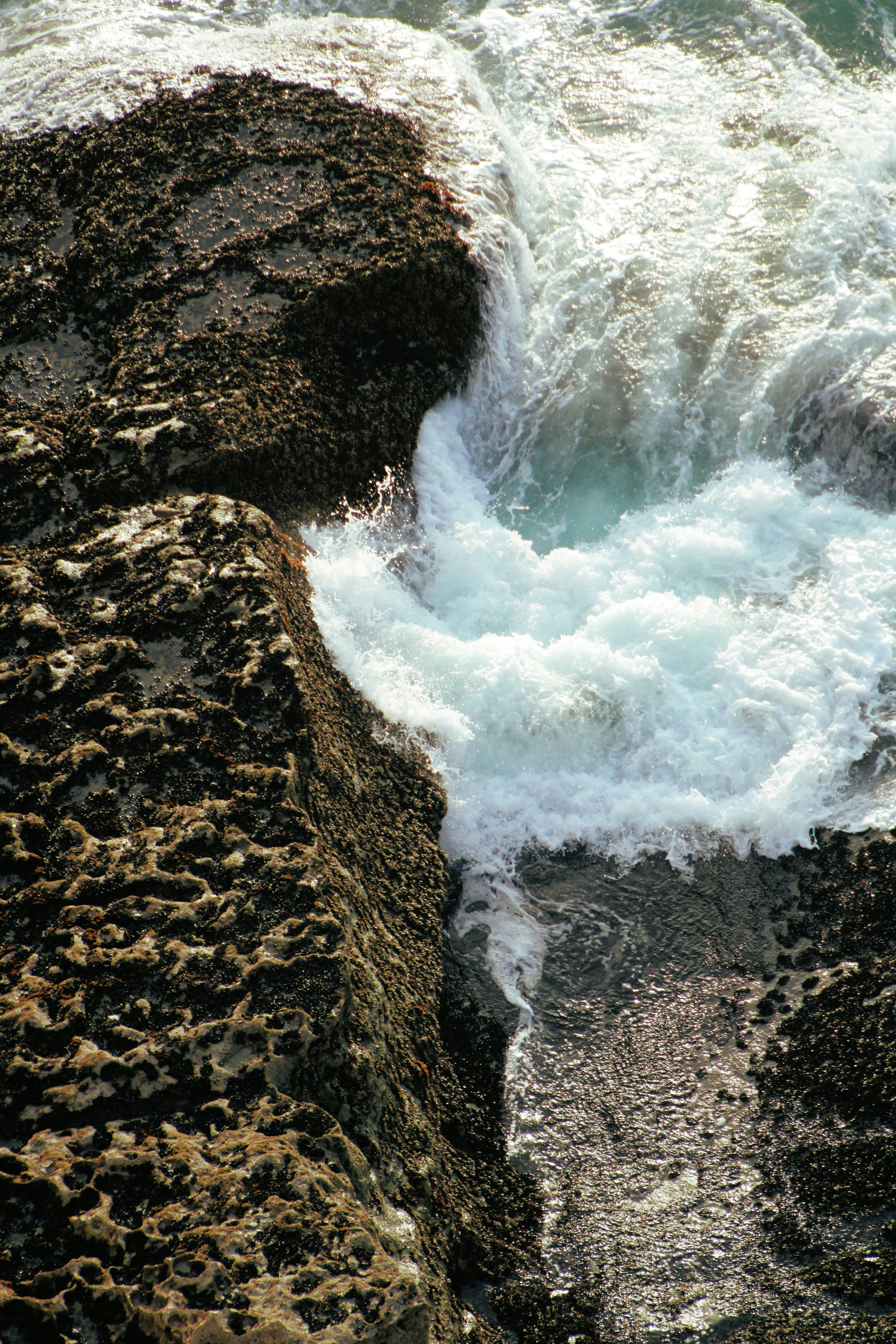 Crevasse of Foam: Waves Encircle Rugged Shore