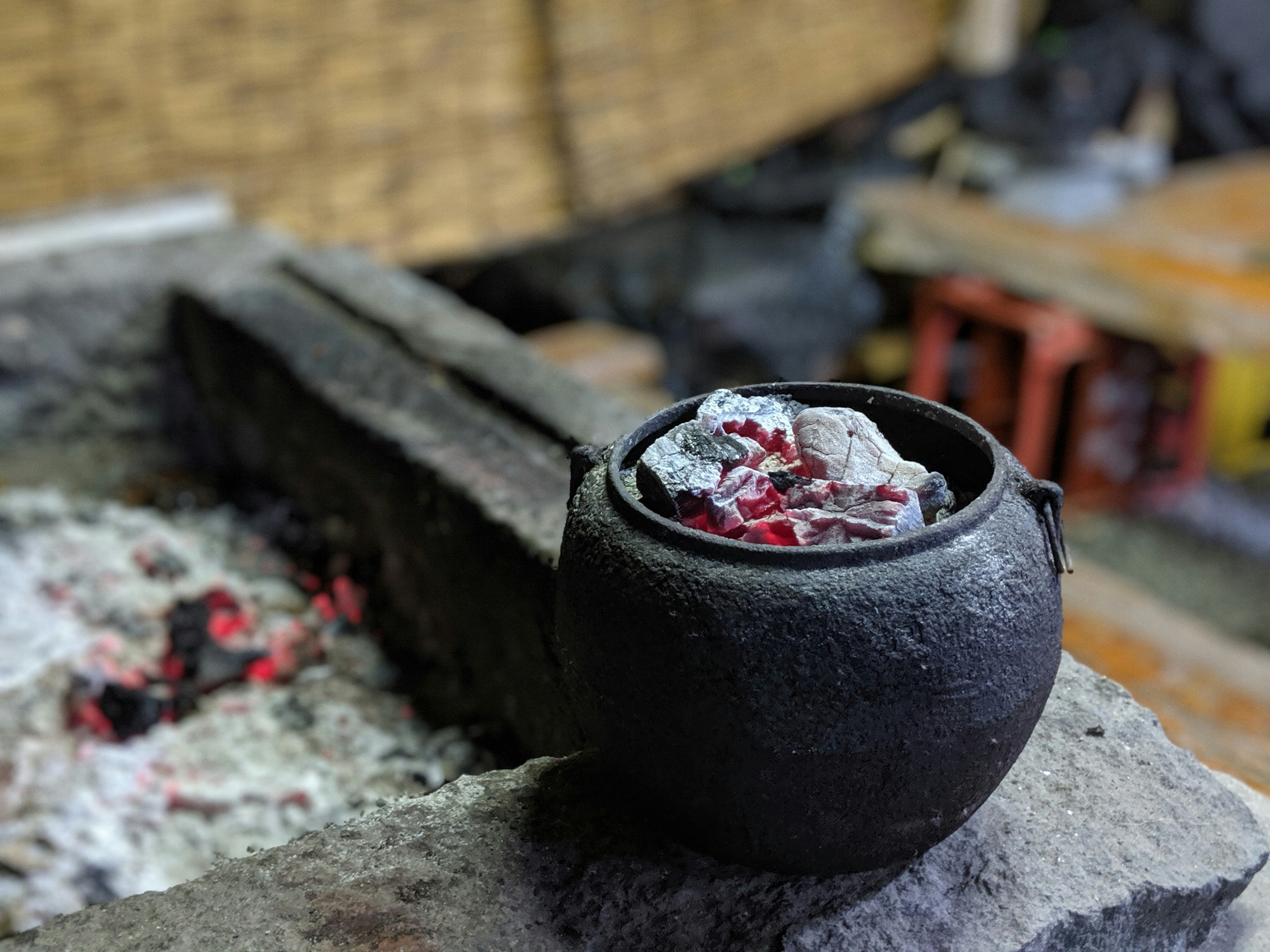 Emberbound: A Worn Iron Pot Resting on a Stone Hearth