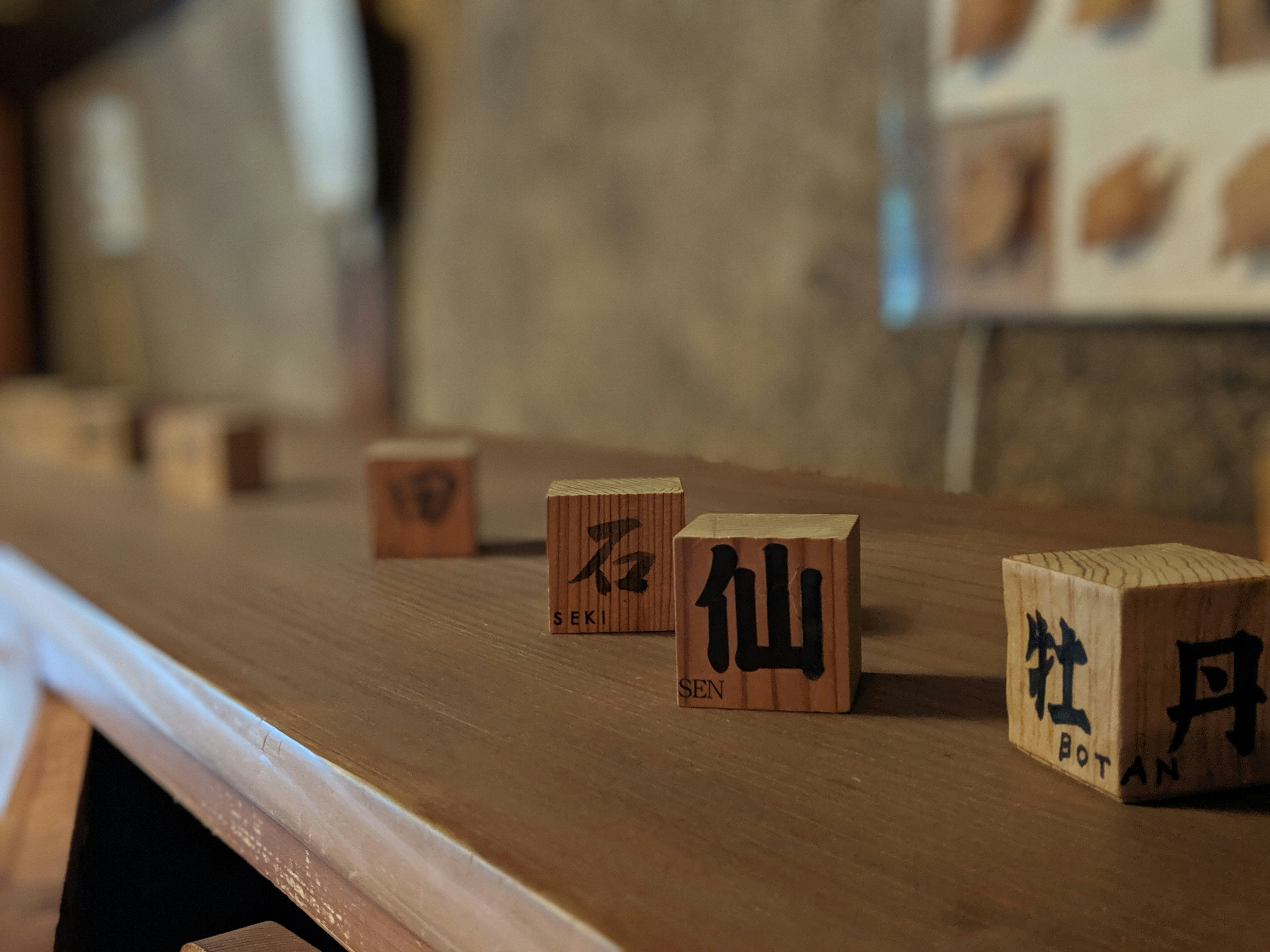 Row of Kanji Blocks on a Sunlit Table: A Quiet Still-Life Study