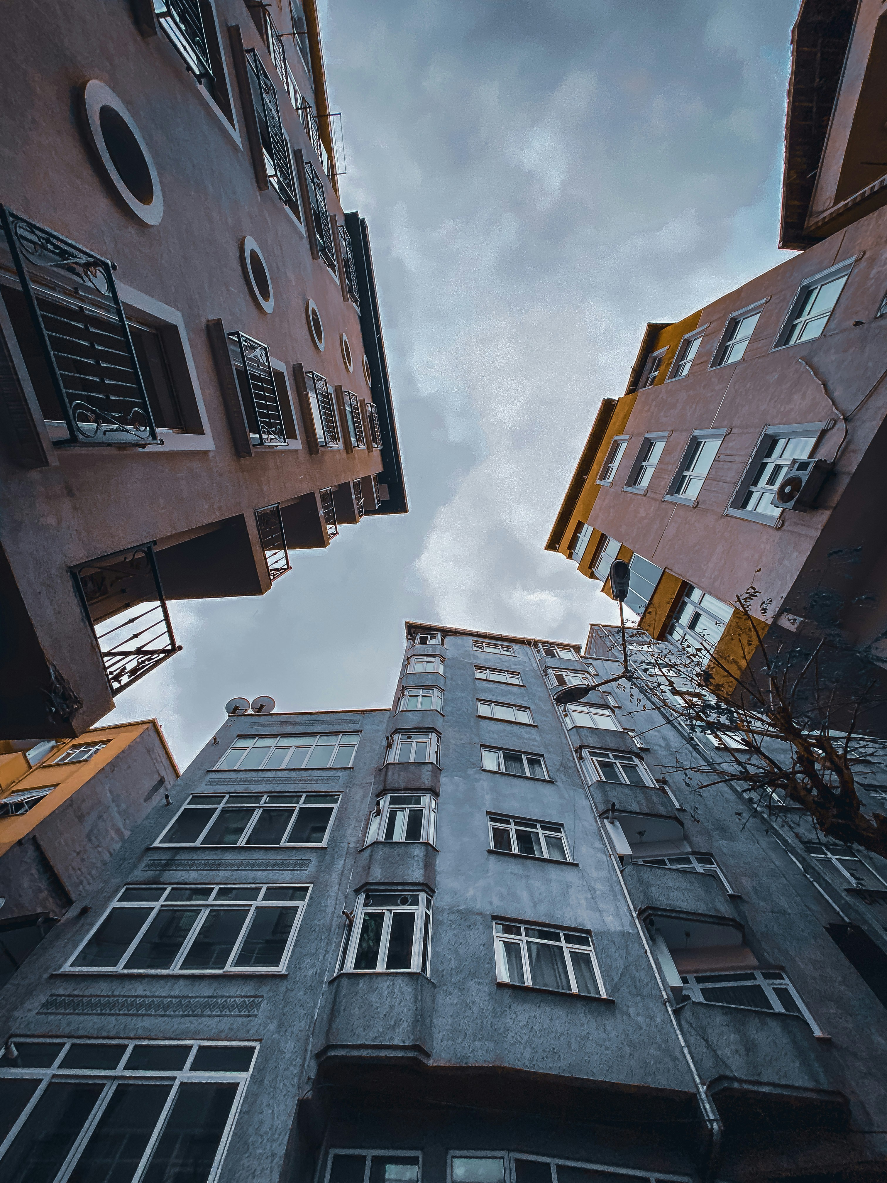 Brown and gray concrete building under white clouds during daytime ...