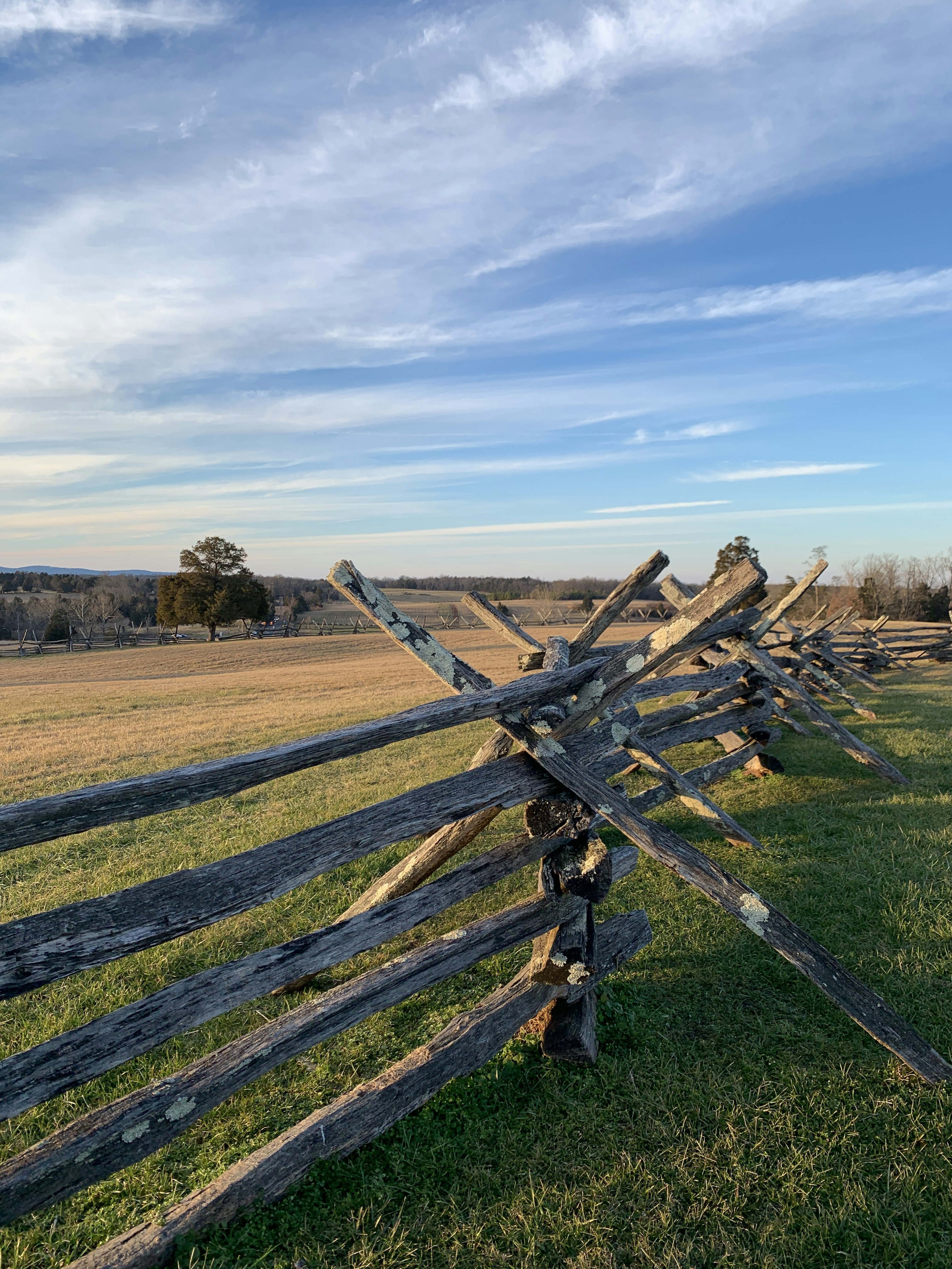 Weathered split-rail fence marching toward the horizon