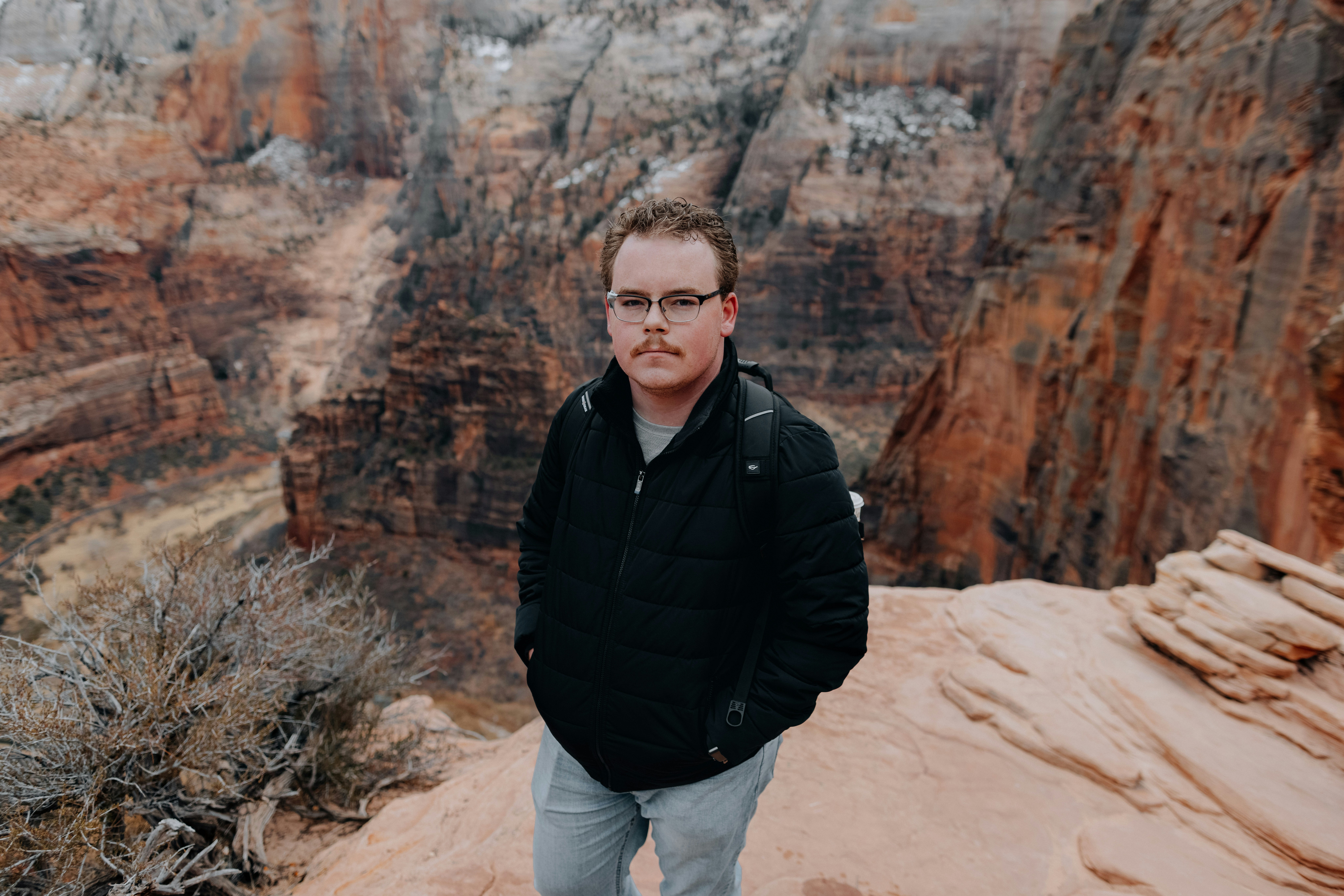 Solitary Hiker Framed by Rust-Red Canyon Walls