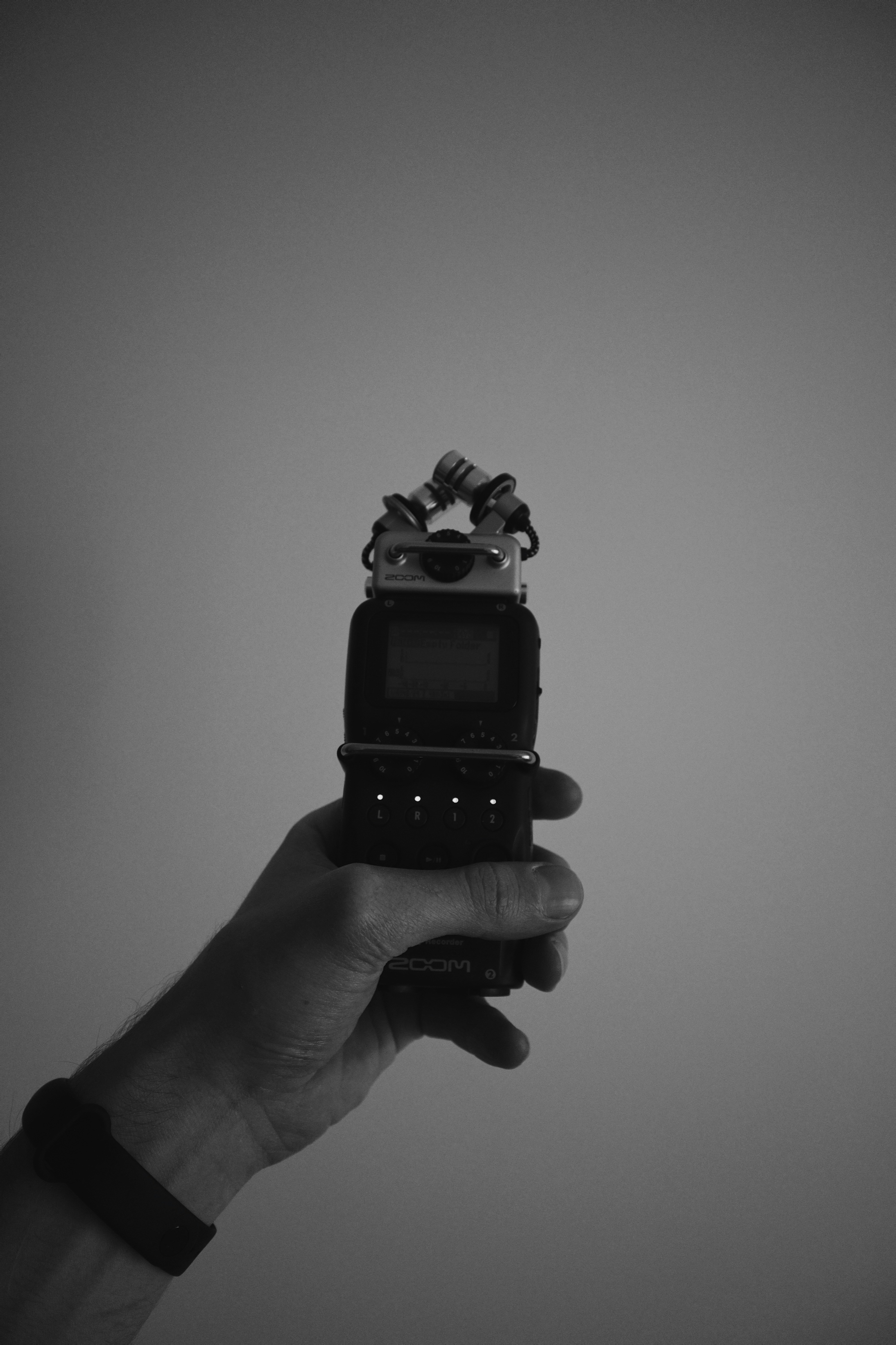 person holding black digital device