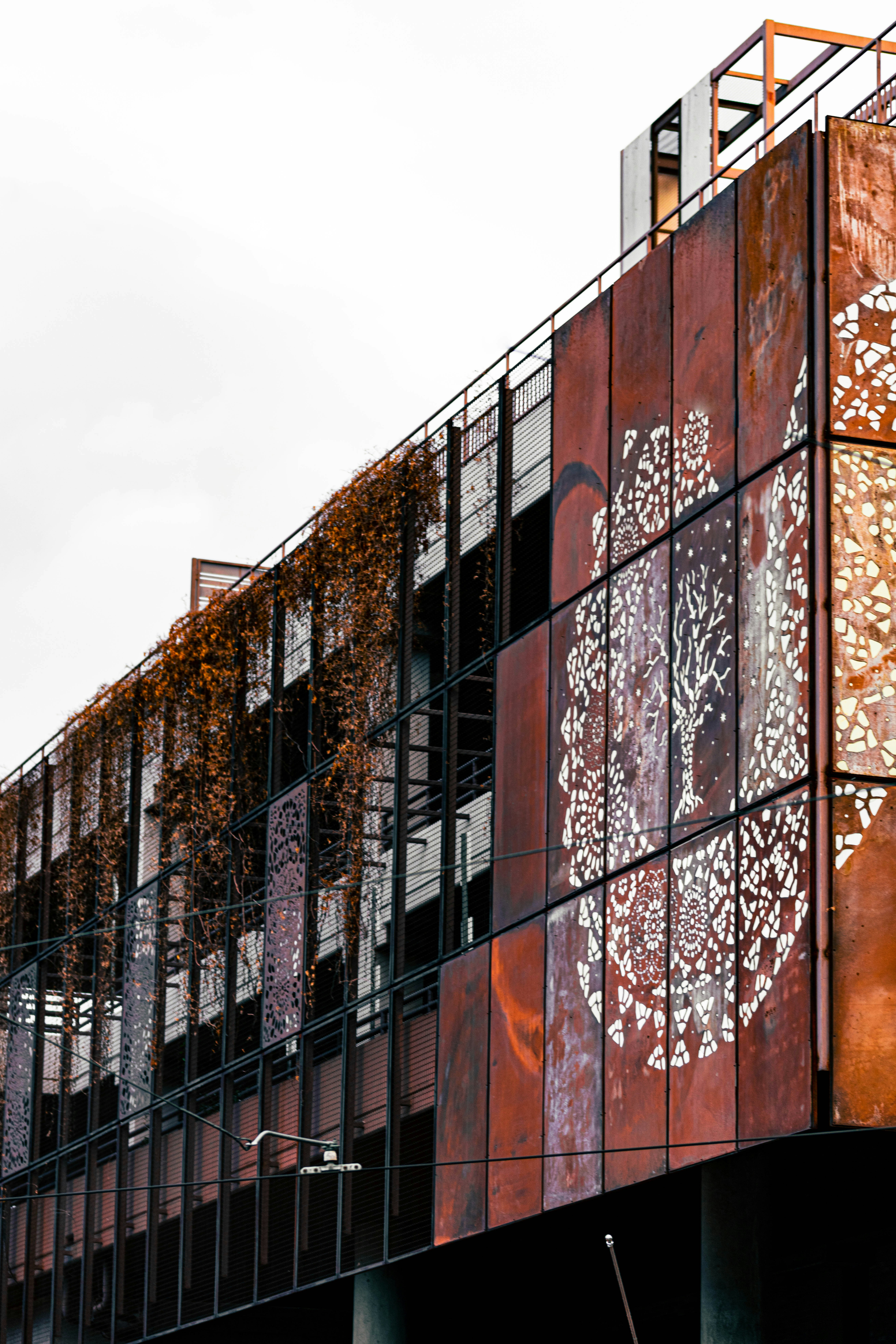 Lacework on Rust: Circular Motif Across a Modern Facade