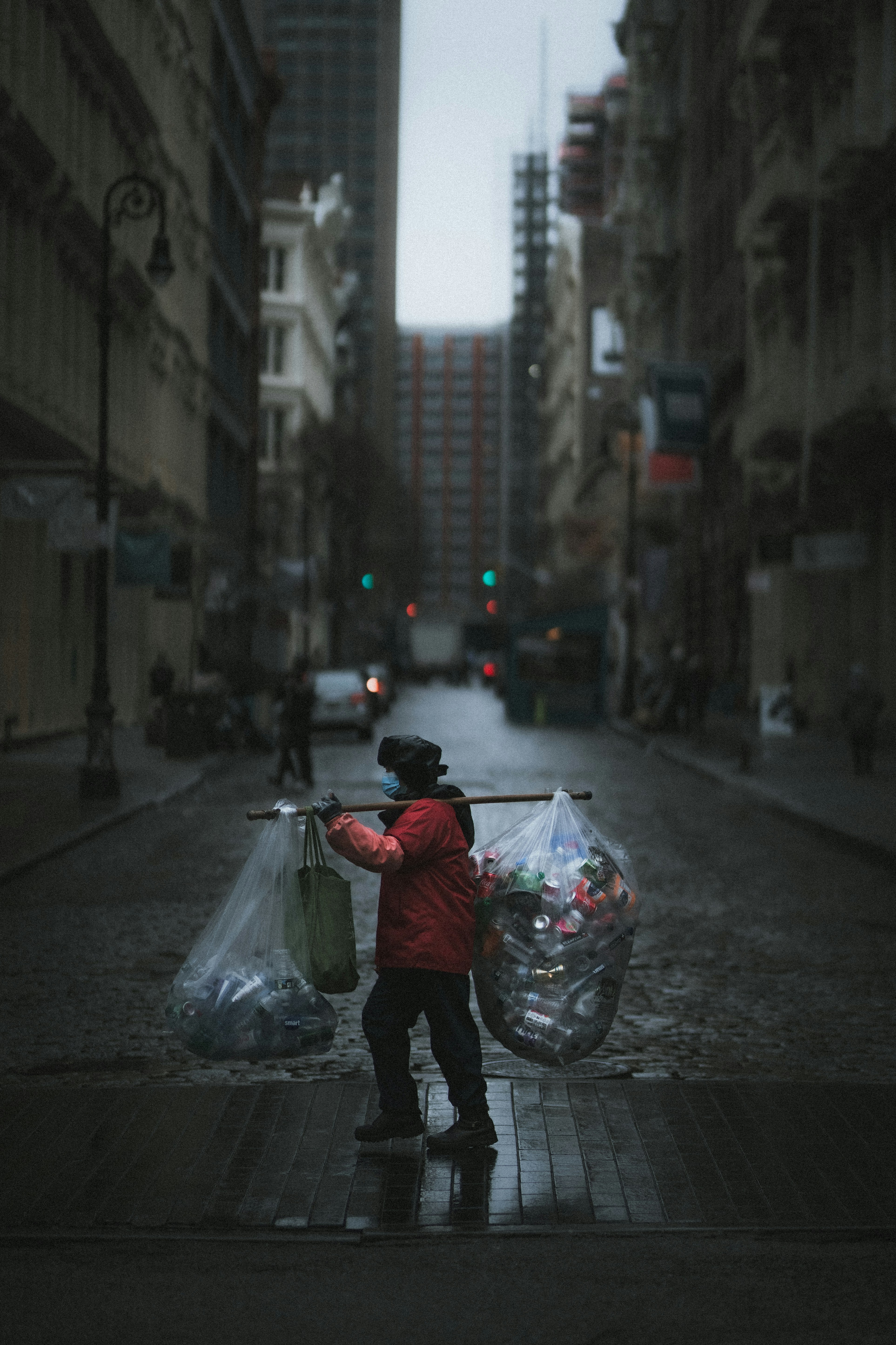 Evening Burden on a Rain-Slick Avenue