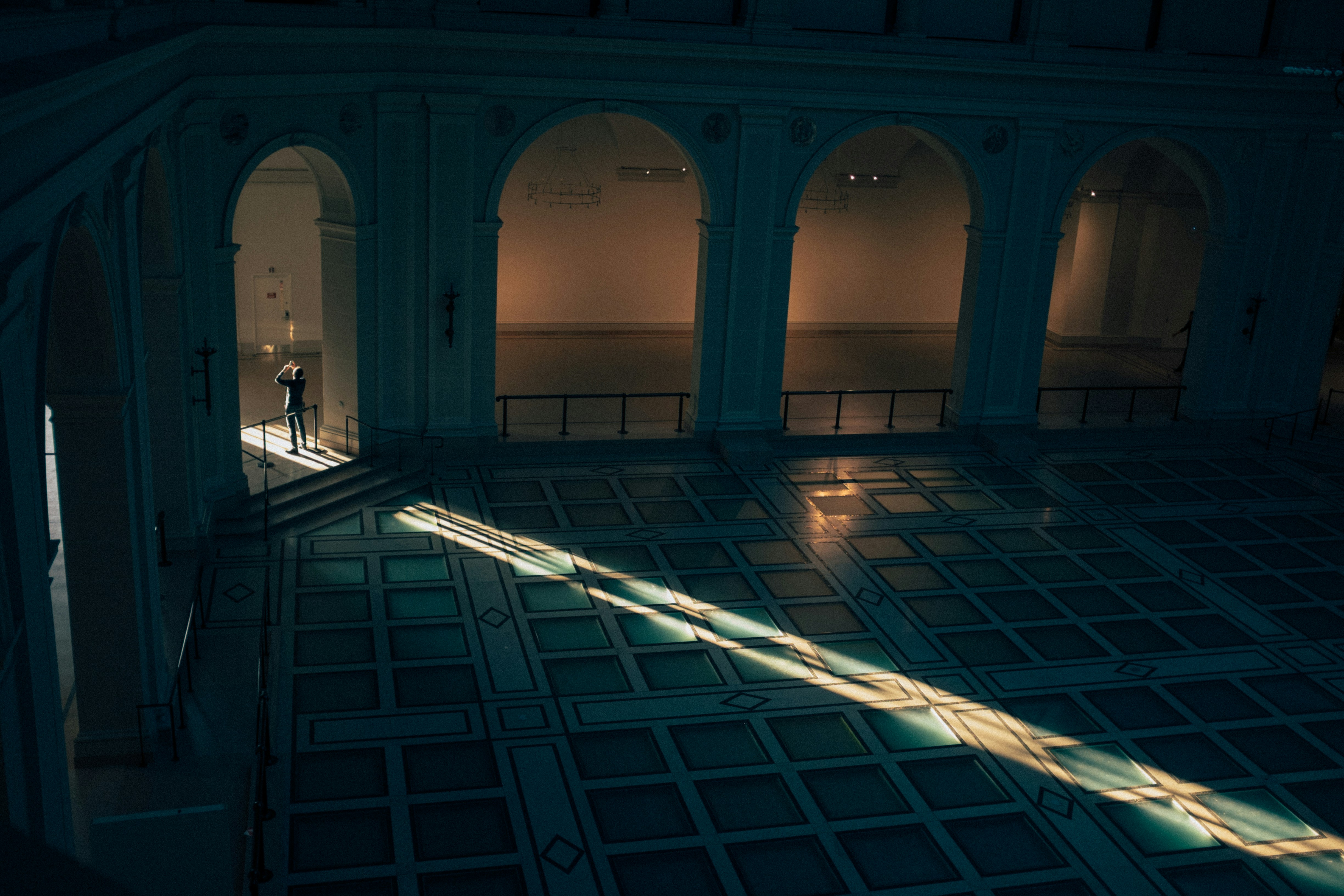 Sunbeam Across the Archway: A Silent Figure in the Grand Hall