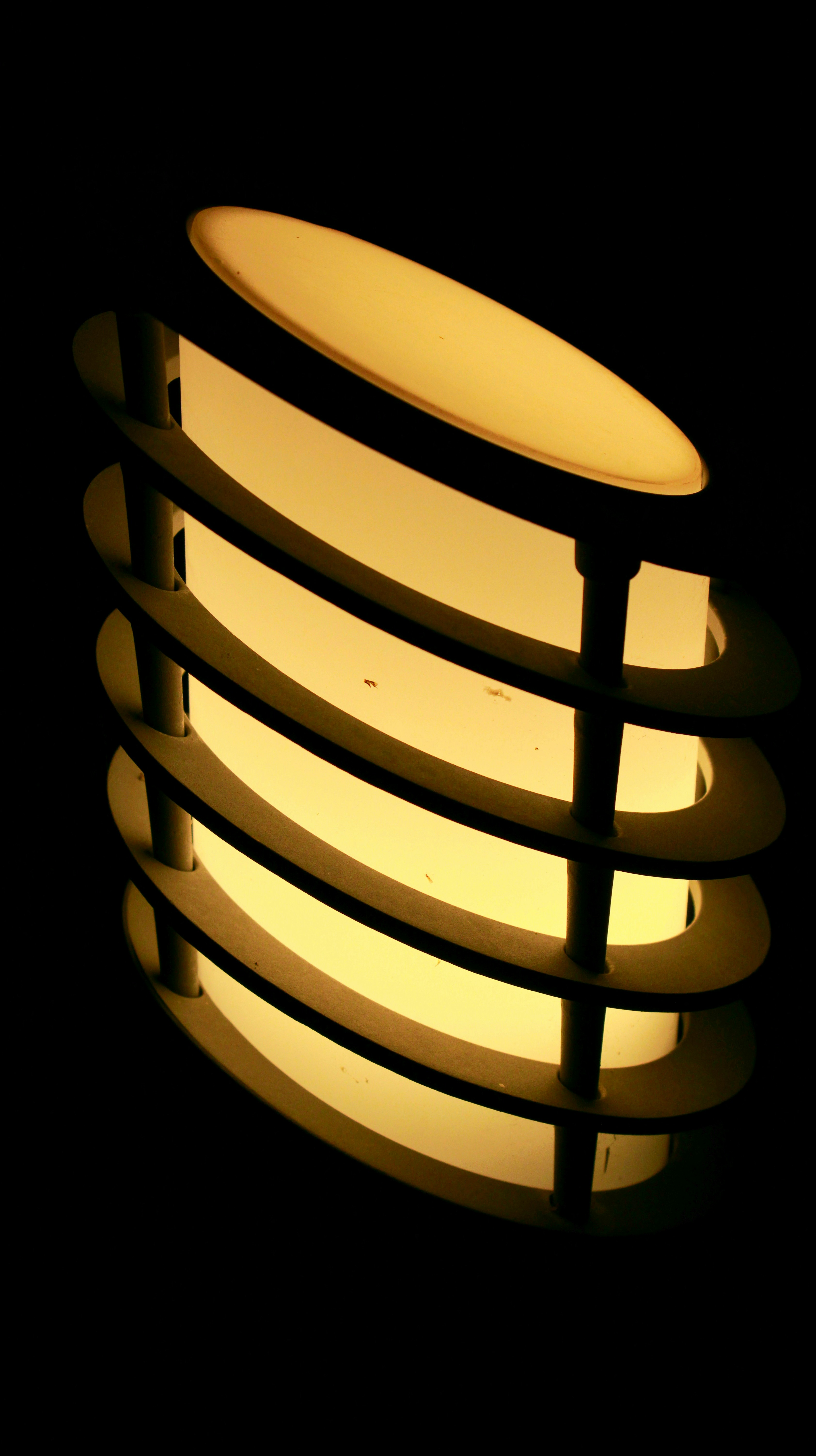Amber Rings in Night: A Close-Up of a Lantern's Warm Cage