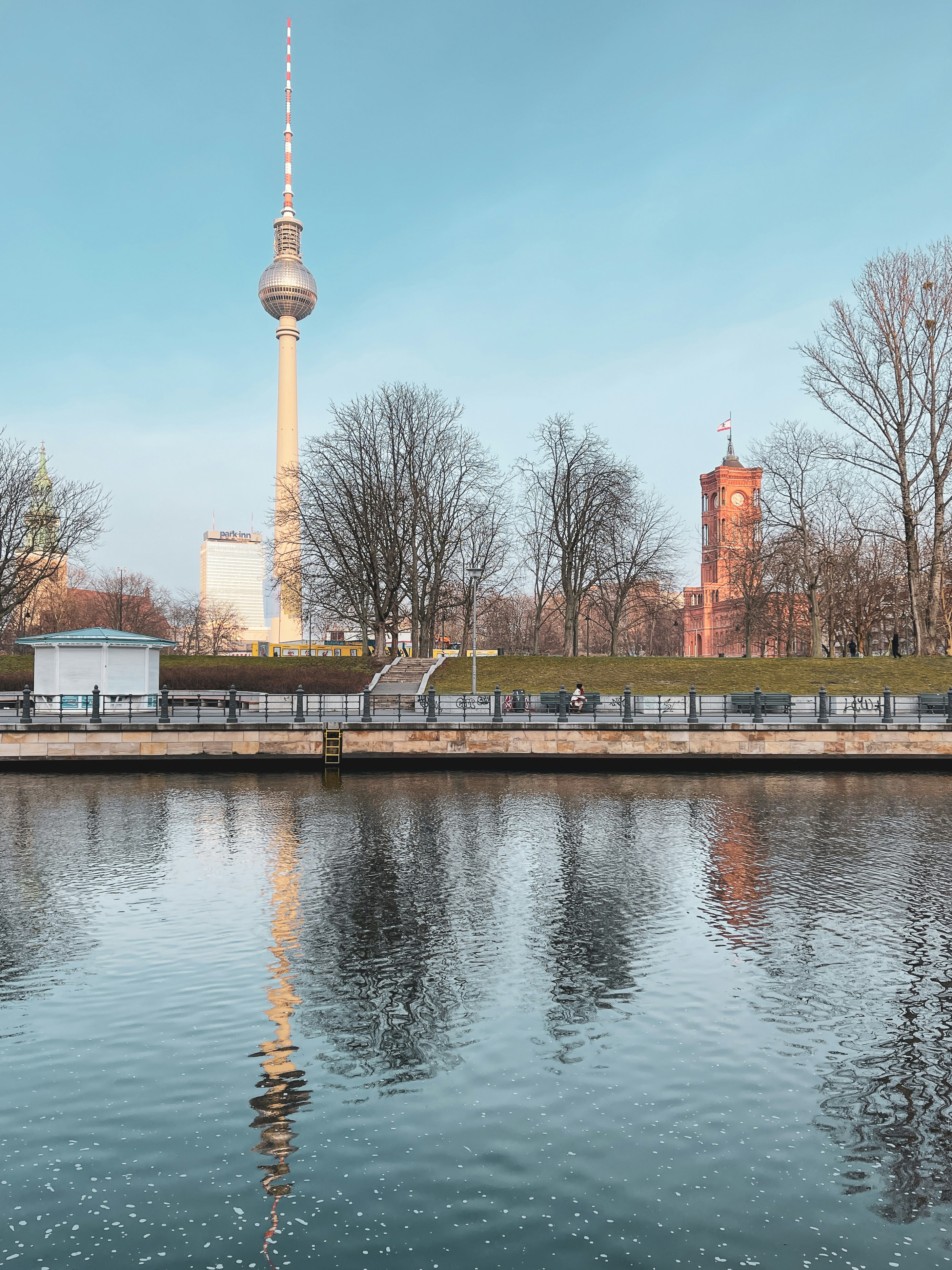 brown and white concrete building near body of water during daytime