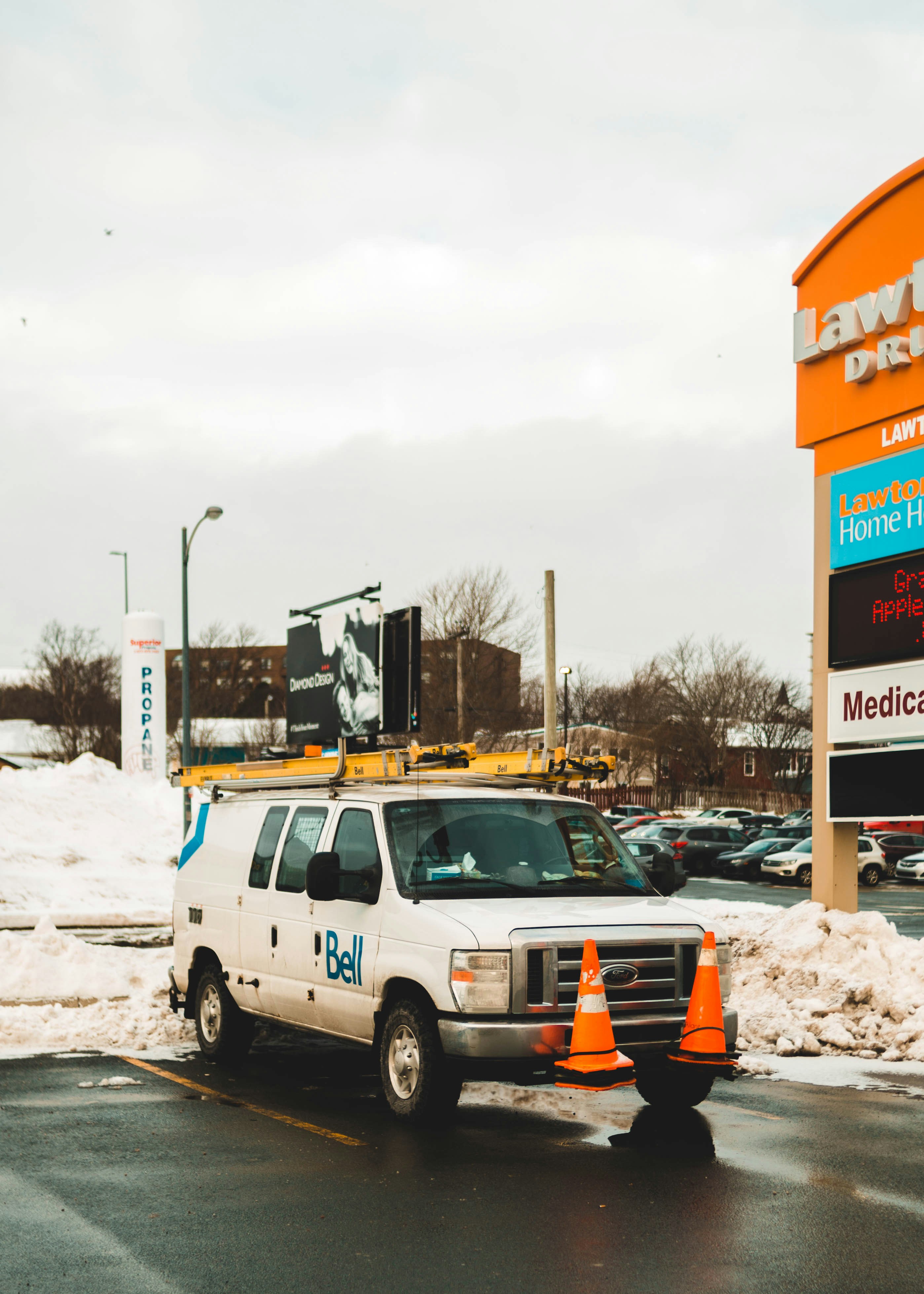 Utility van under winter light at a busy shopping center