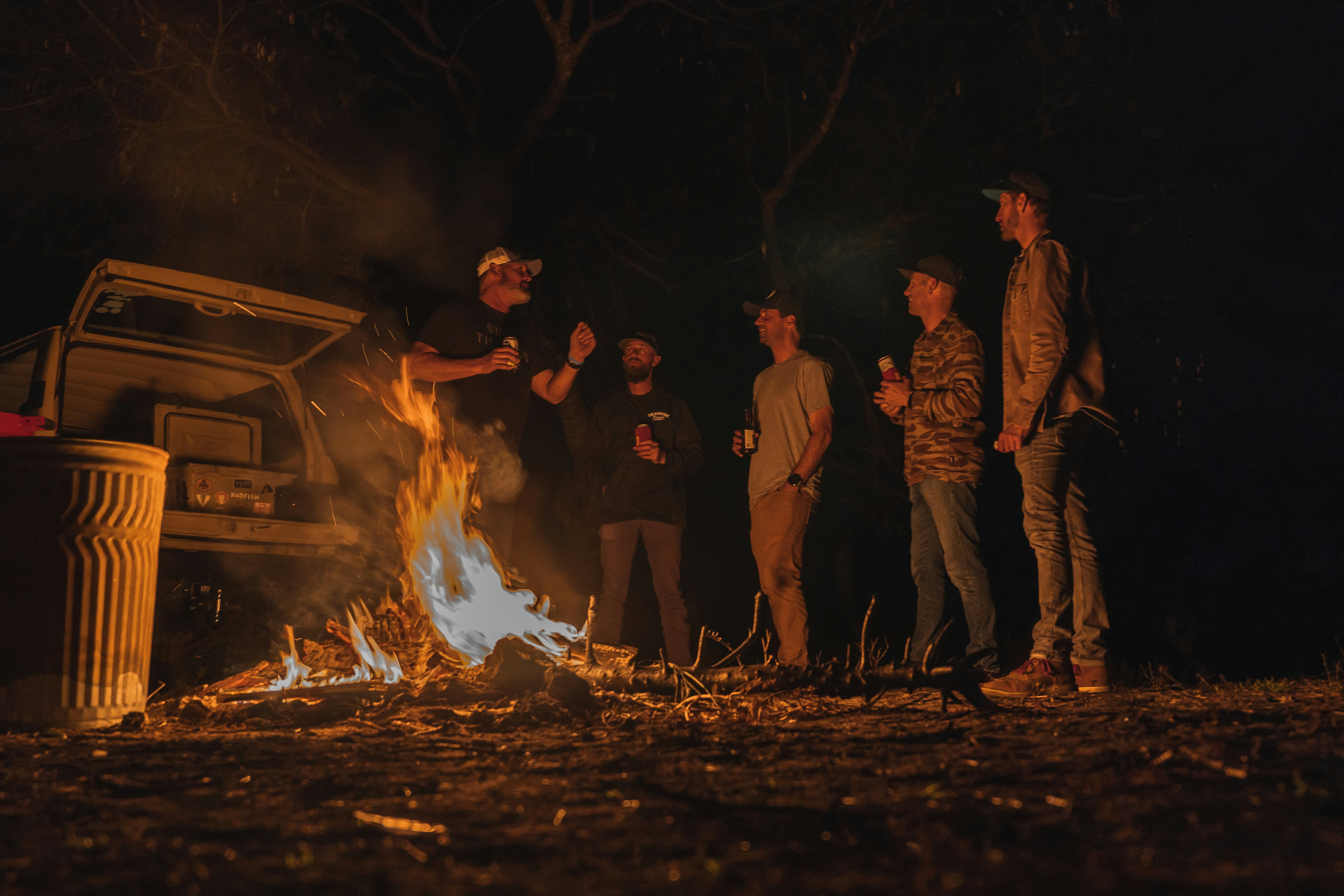 Group of men standing near bonfire photo – Free Human Image on Unsplash