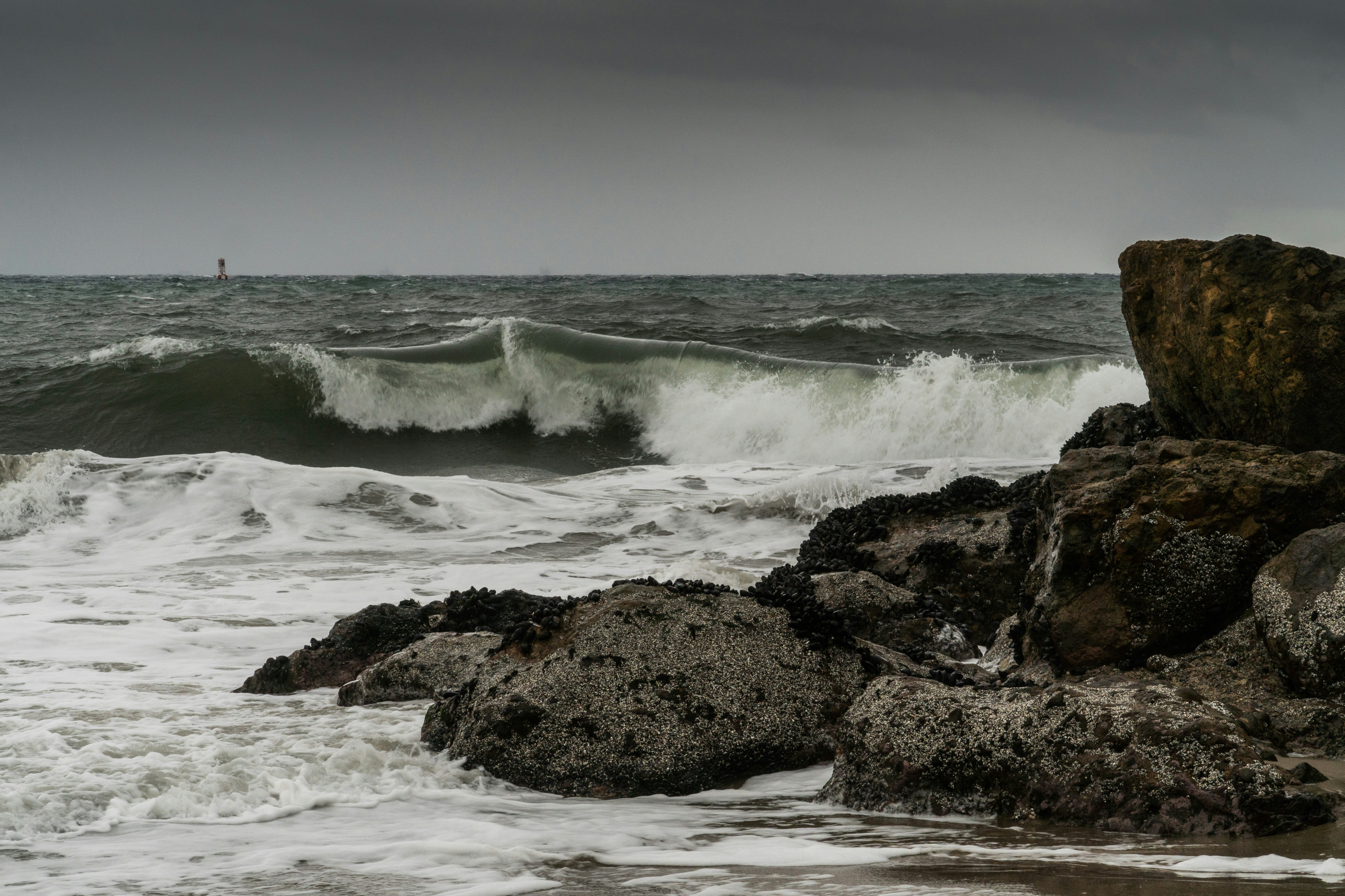 Ocean waves crashing on brown rock formation during daytime photo ...